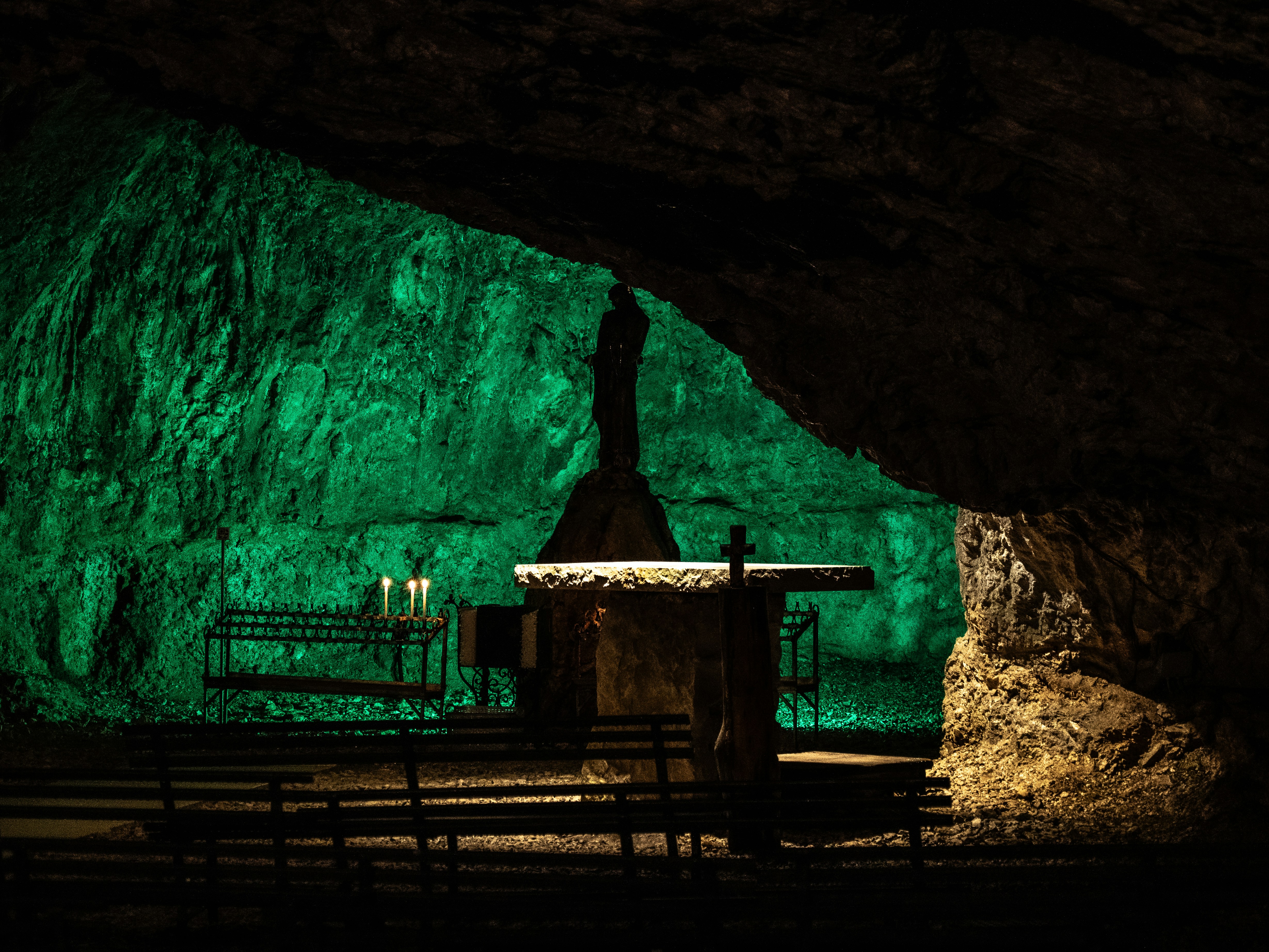Candlelit Altar in a Dim Limestone Cave