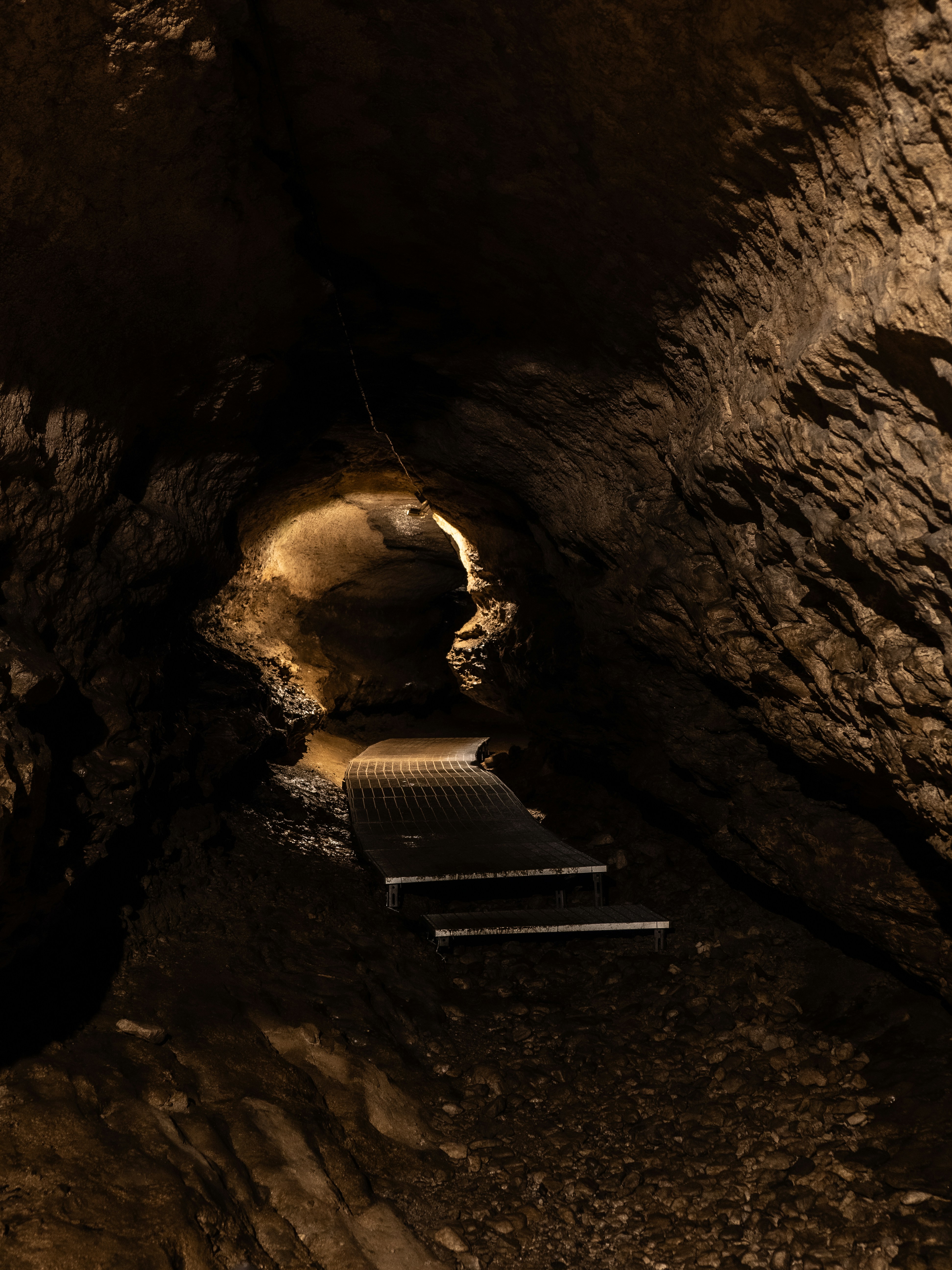 Emerald Passage: A Narrow Mine Tunnel Drenched in Warm Light