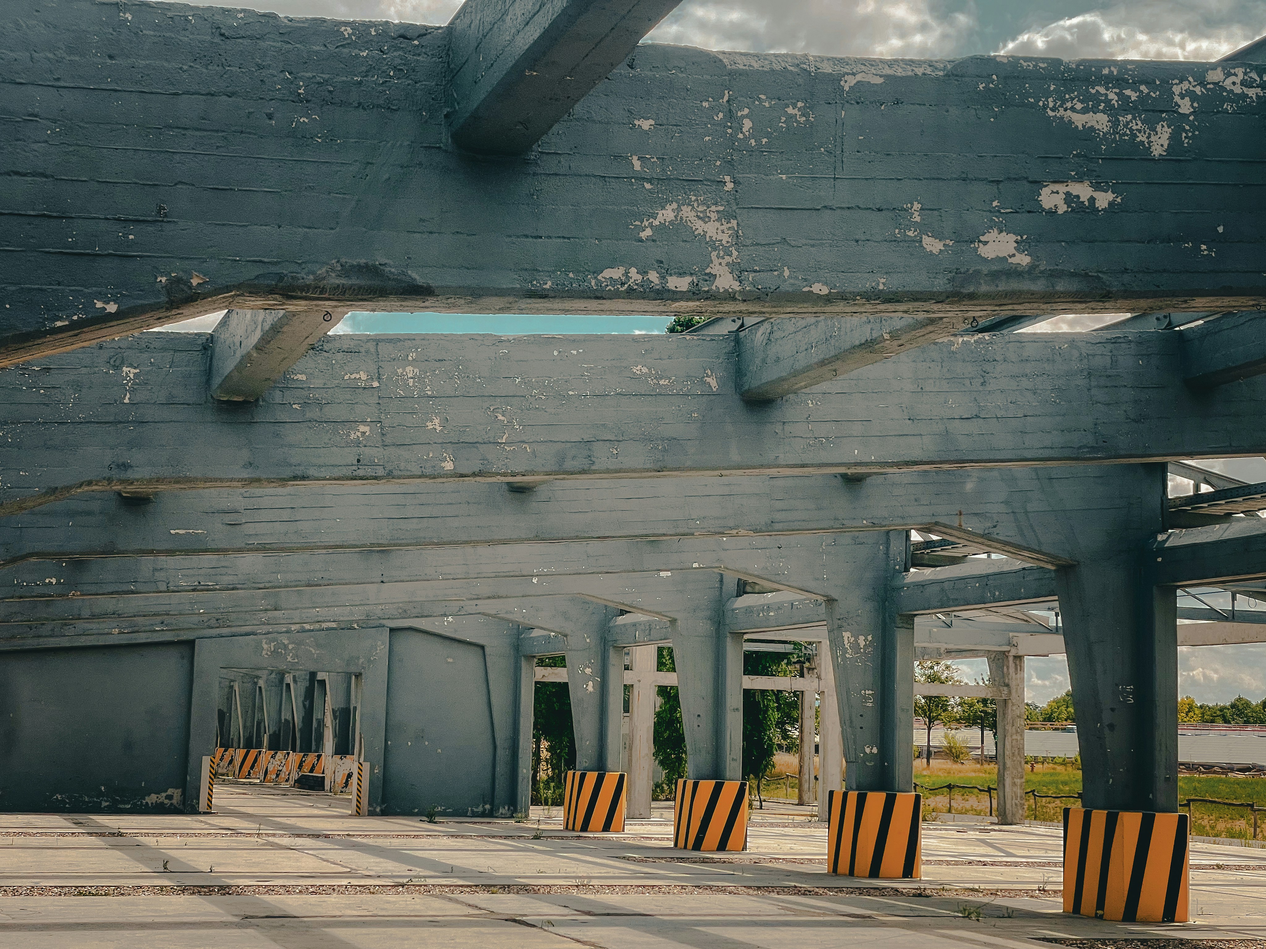 Blue Concrete Gateways: A Quiet Parking Structure Beneath Sky