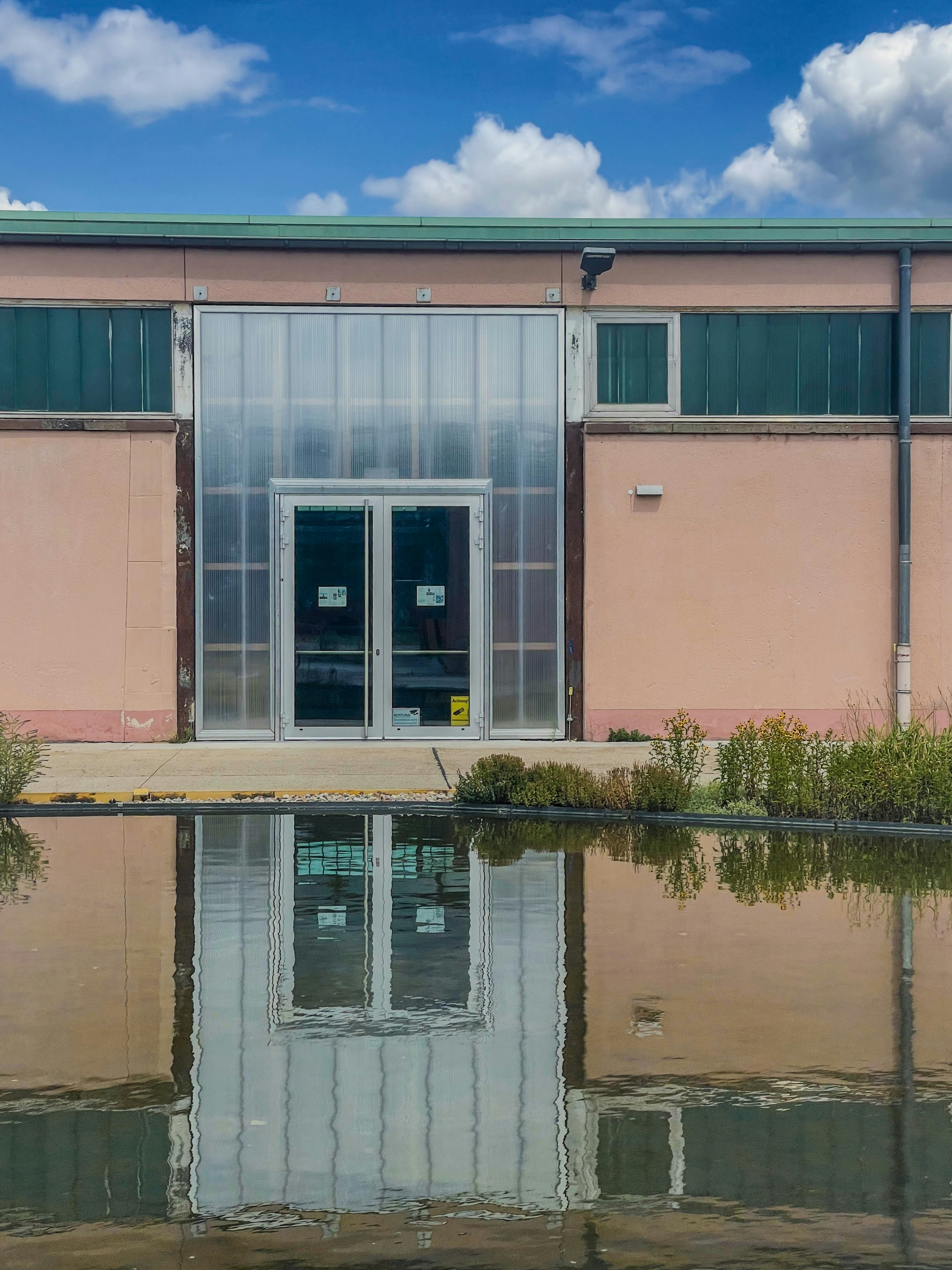 Glass Doors at the Edge of a Reflective Pond