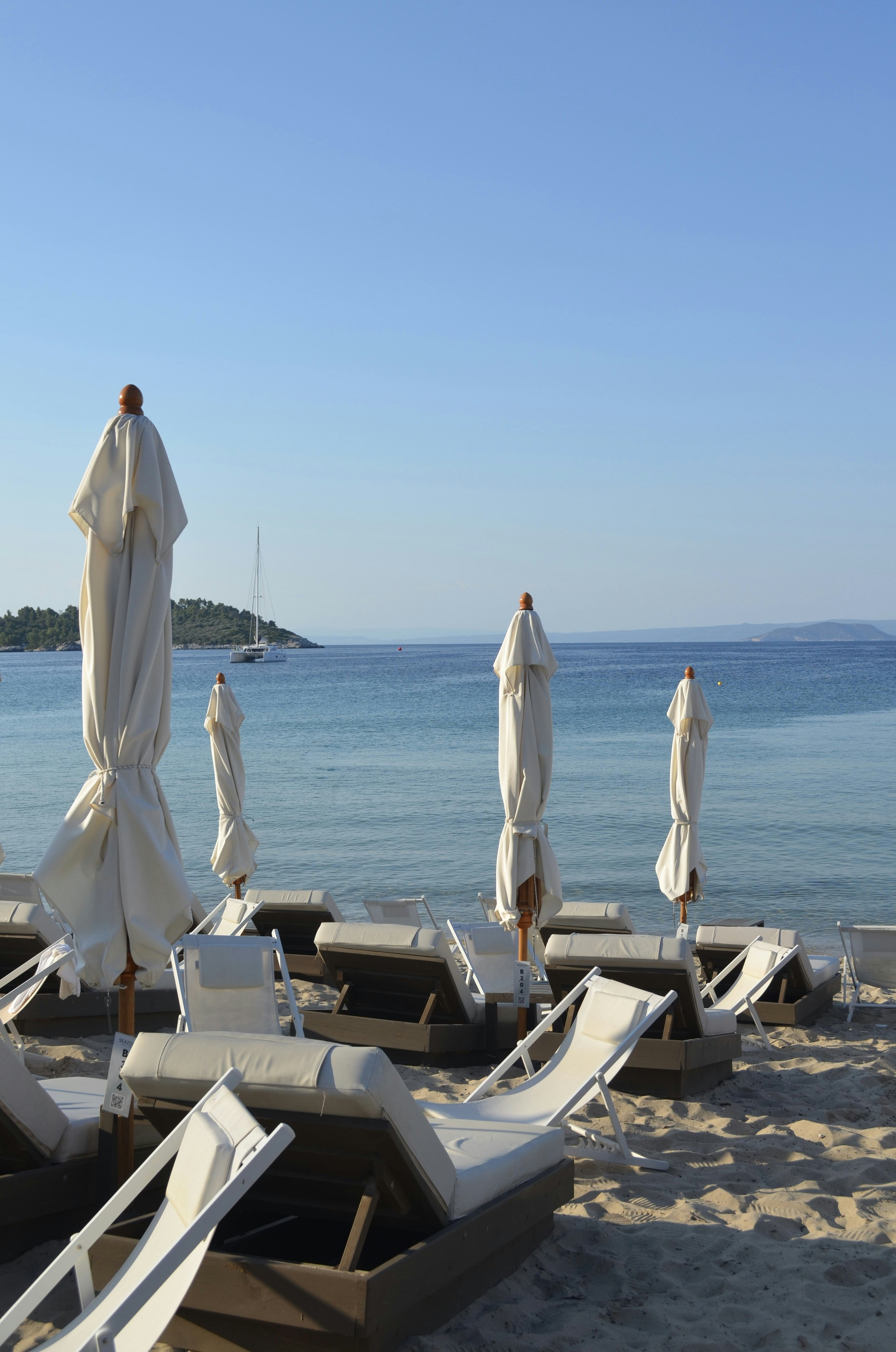 Sofas of the Sea: Beachfront Umbrellas Quietly Stand Guard