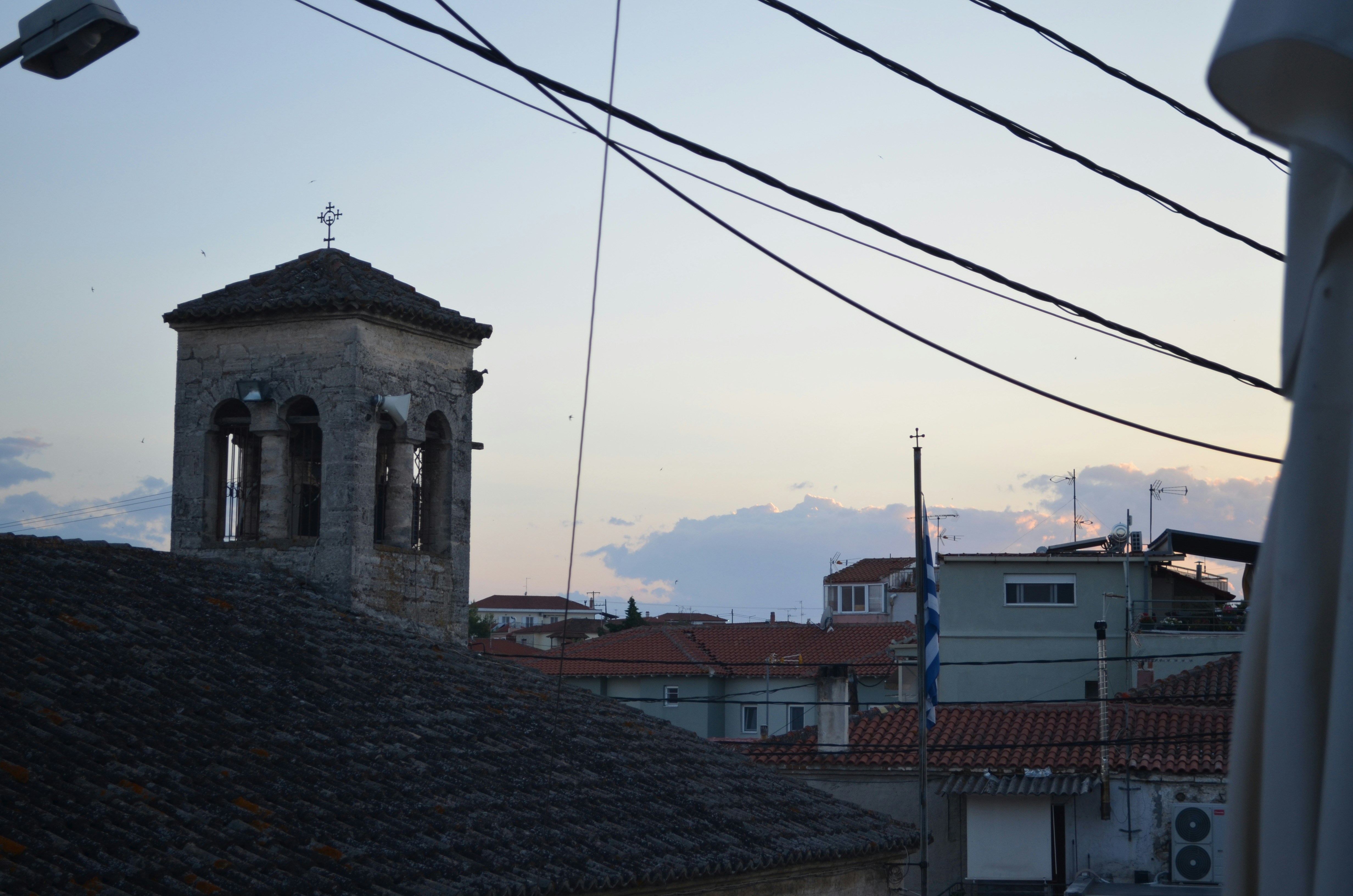 Civic Bell Tower Amid Rooftops at Dusk
