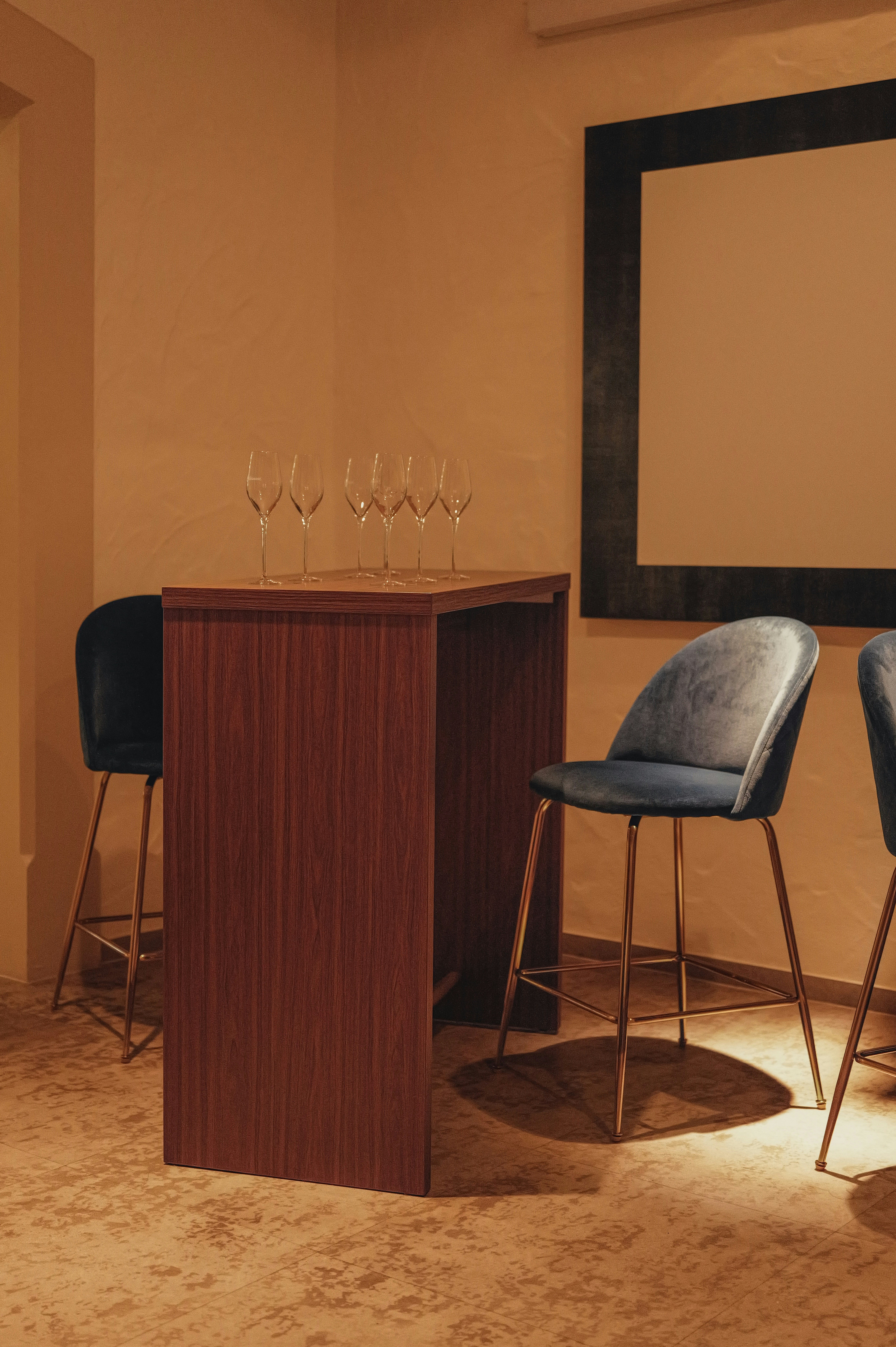 Muted Gold: A Quiet Bar Scene with Marble and Velvet Chairs