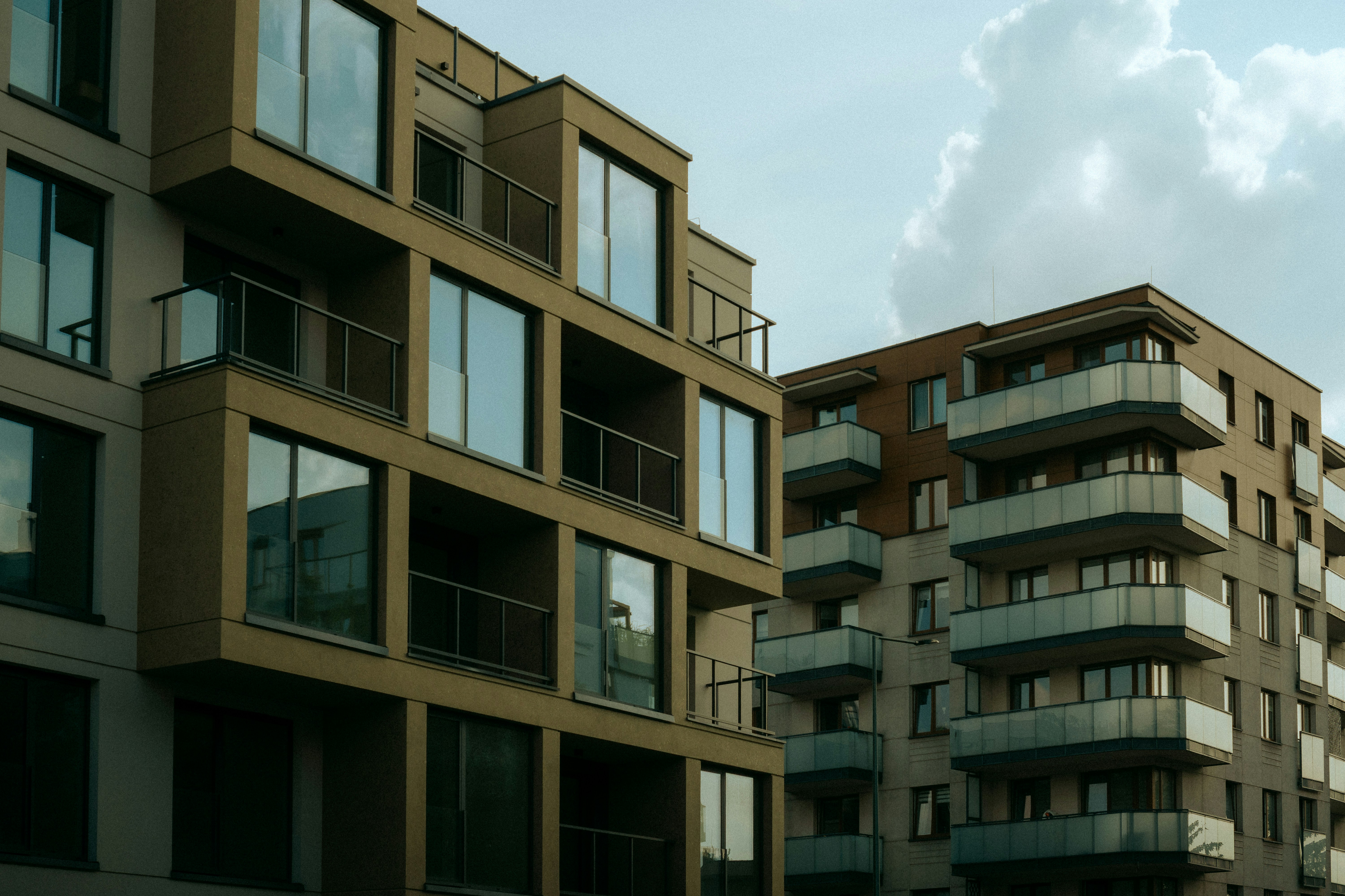 Urban Facade Duo: Modern Blocks Reflecting Sky