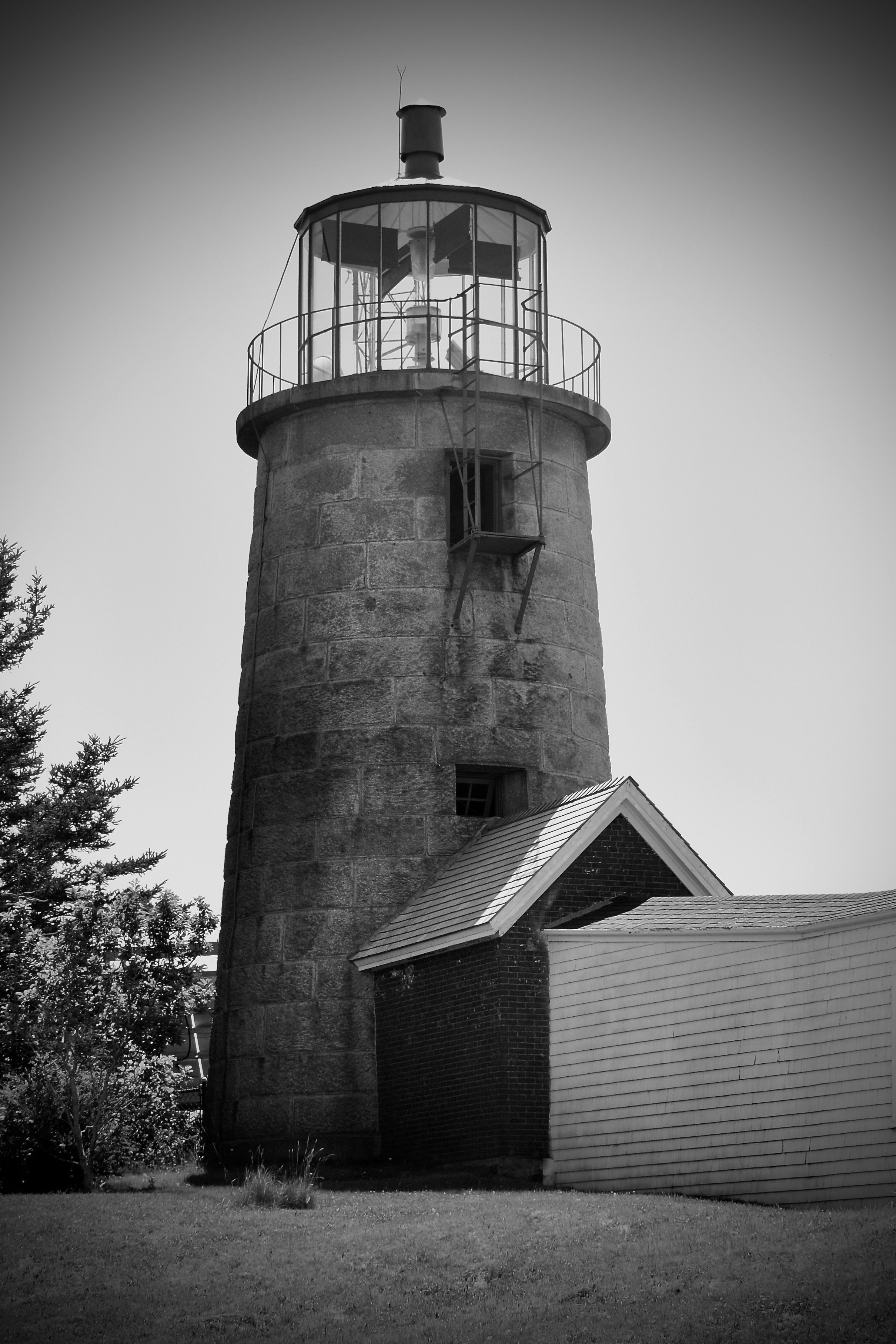 Weathered Beacon: The Stone Lighthouse Named by Shadow