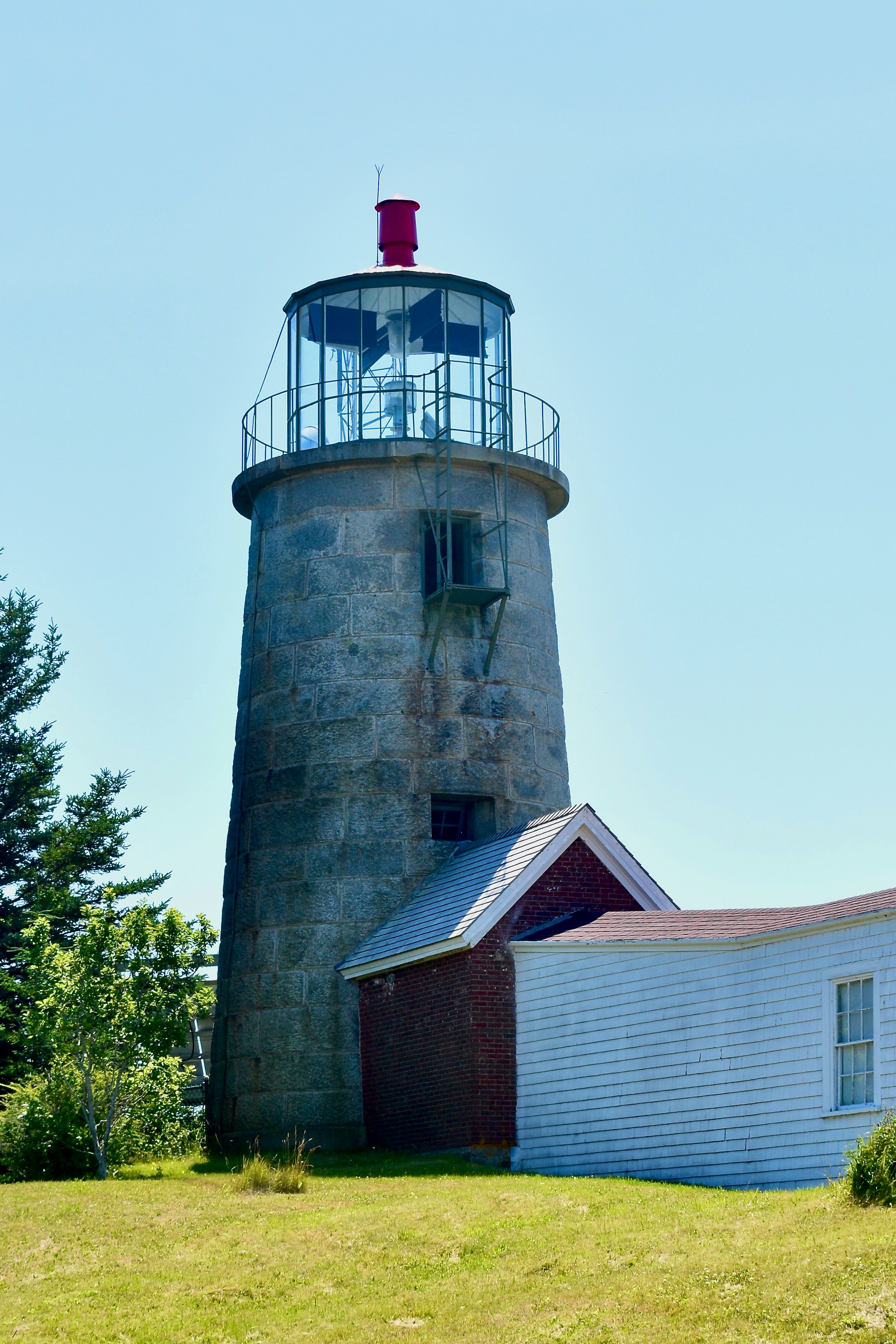 Beaconed Silence: A Weathered Lighthouse Guarding the Green Field