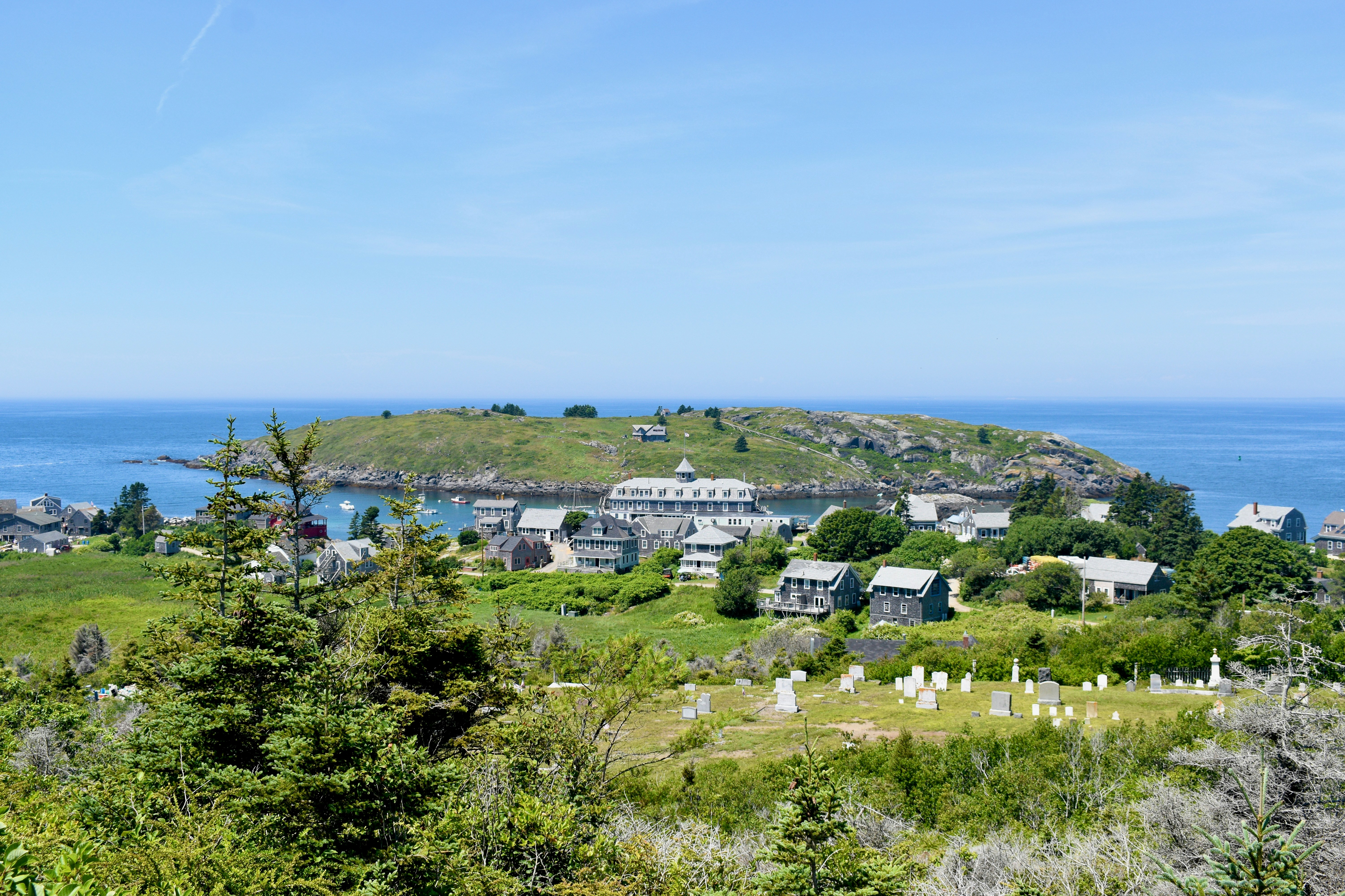 Coastal settlement tucked on a grassy promontory