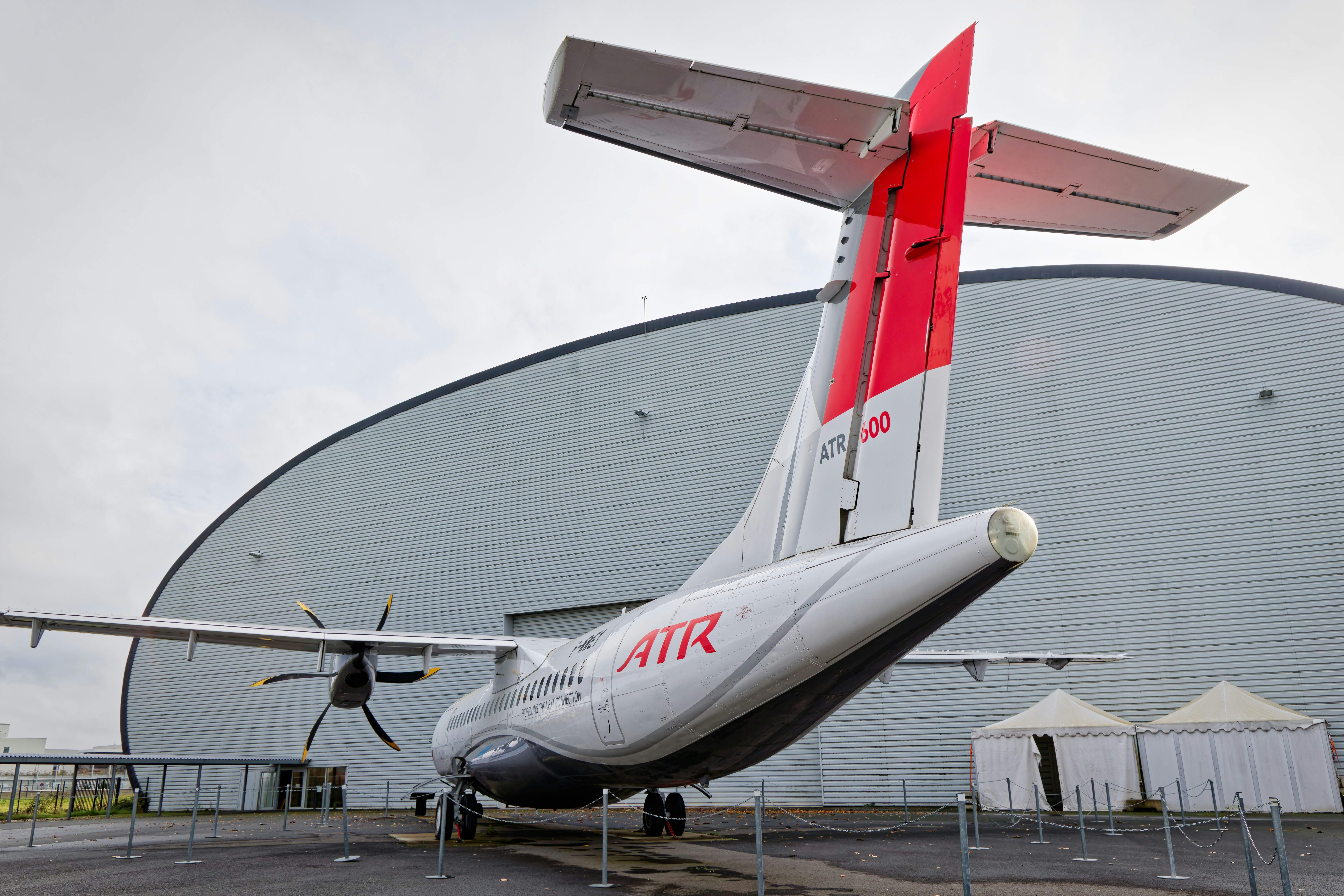 Tail-Tipped Jet Resting at the Edge of a Hangar