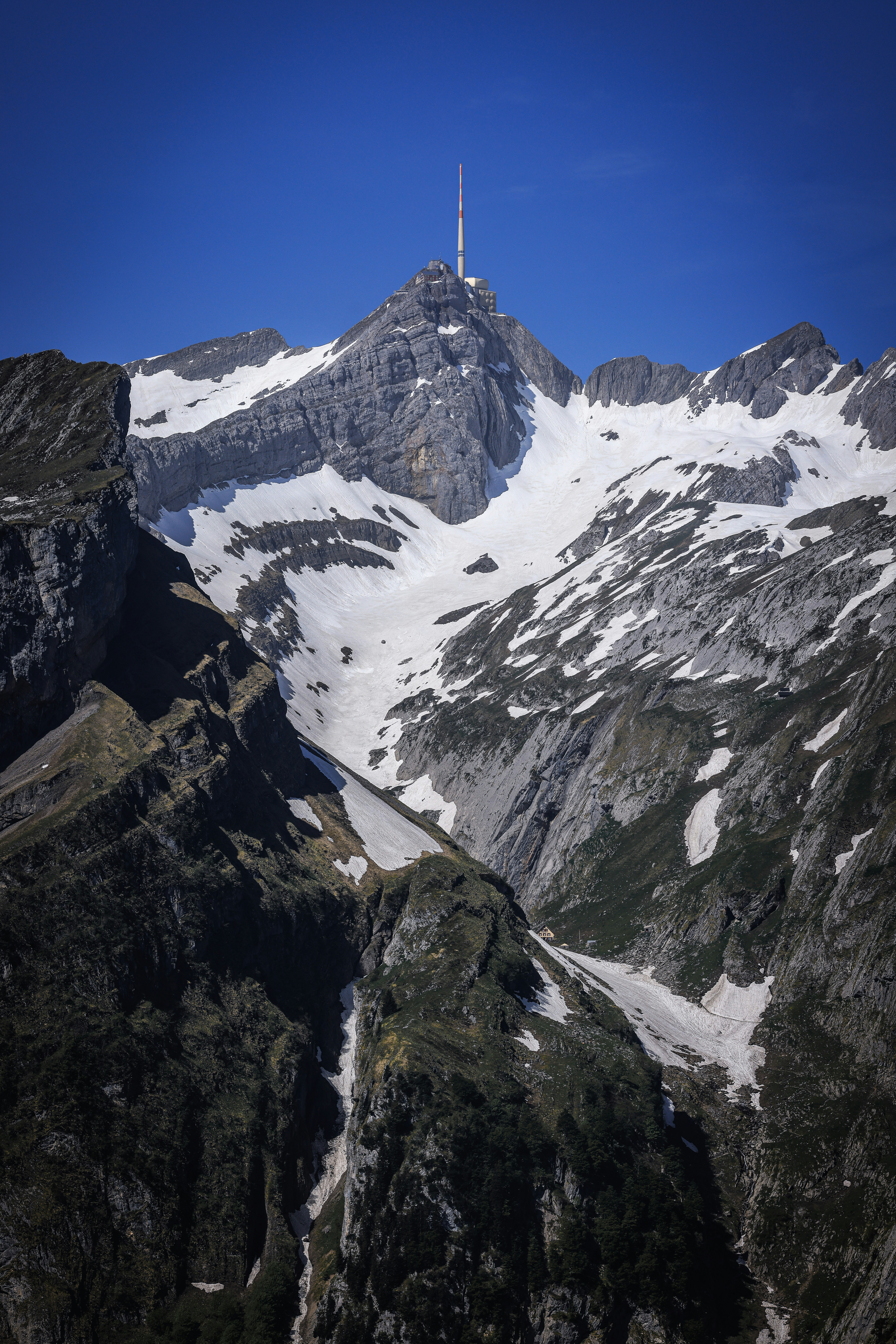 Peak Crown: A Snow-veiled Summit with a Needle-like Antenna