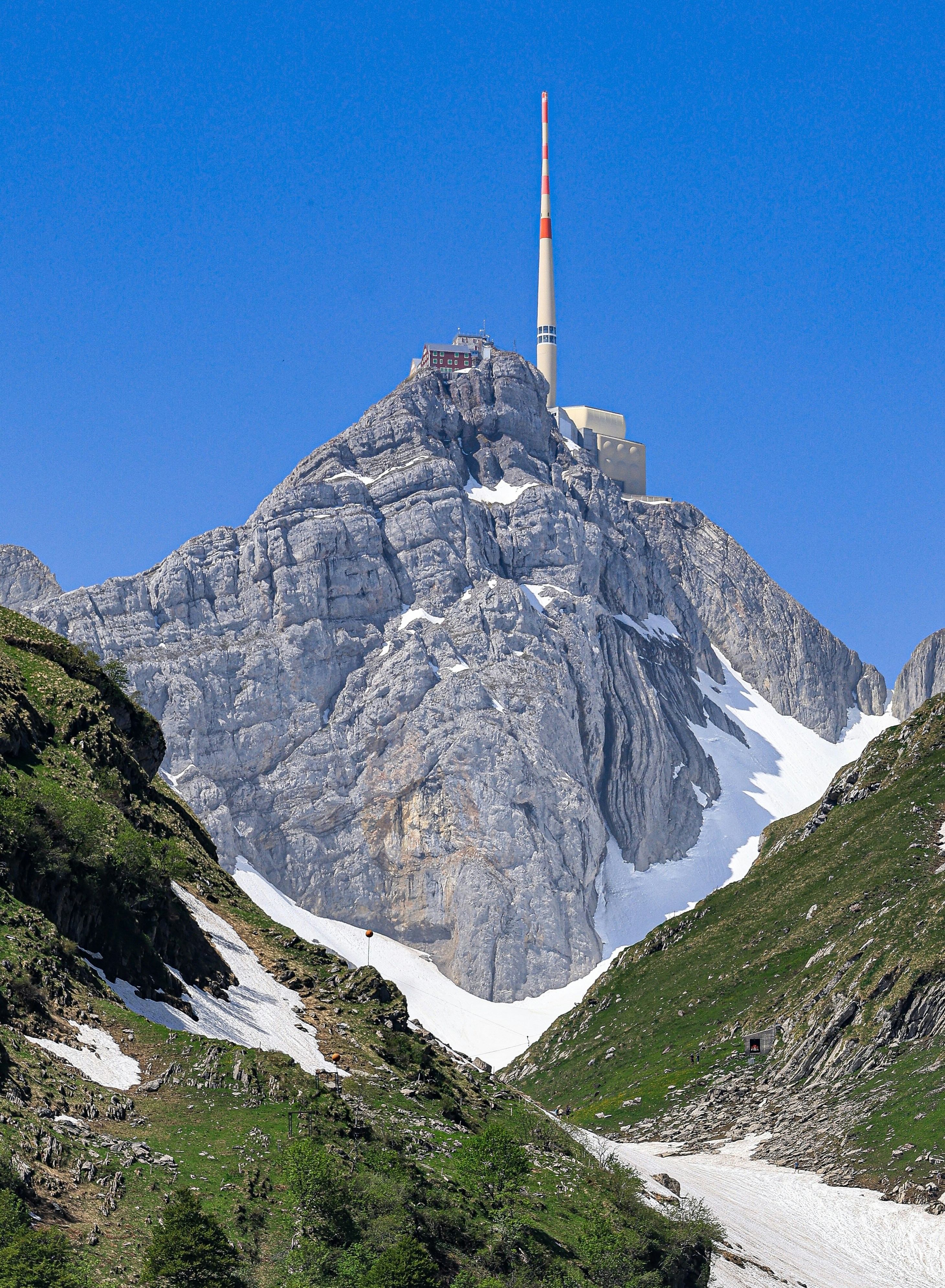 Antenna Crowned Peak: Summit Tower Pierces Alpine Blue