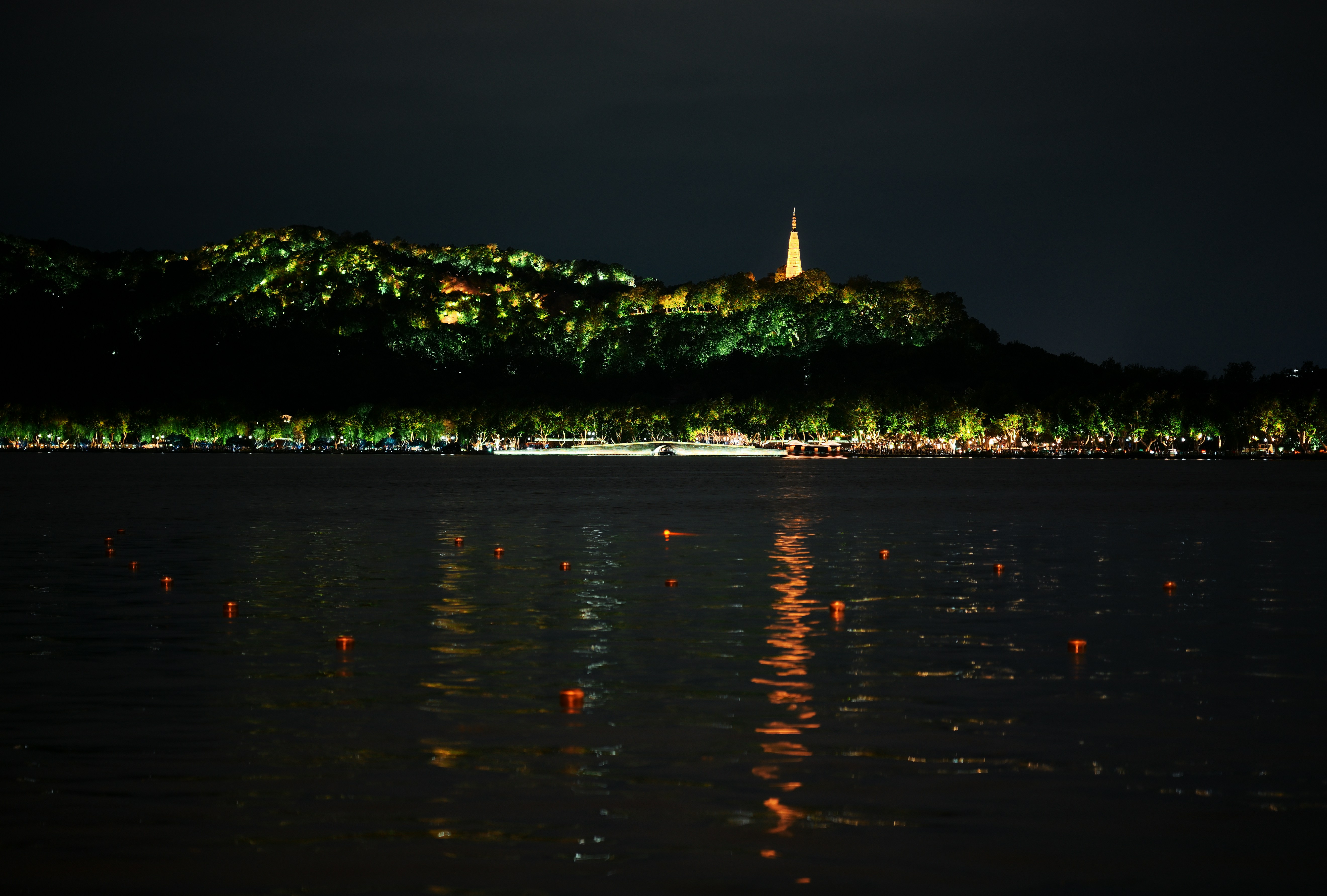 Lighthouse Crowned by Moonlit Hill
