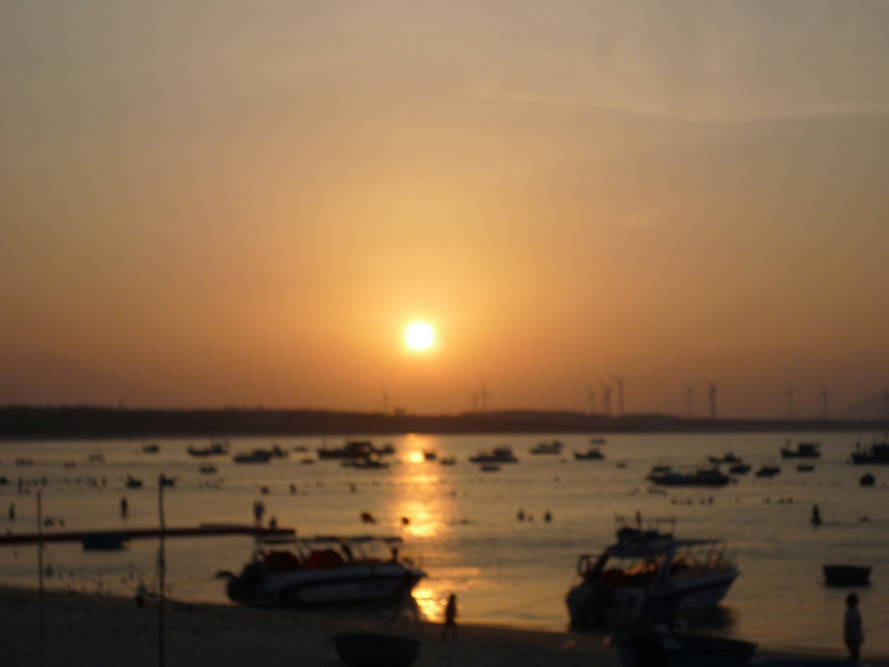 Sunlit Harbor: Boats Silhouetted as Dusk Settles
