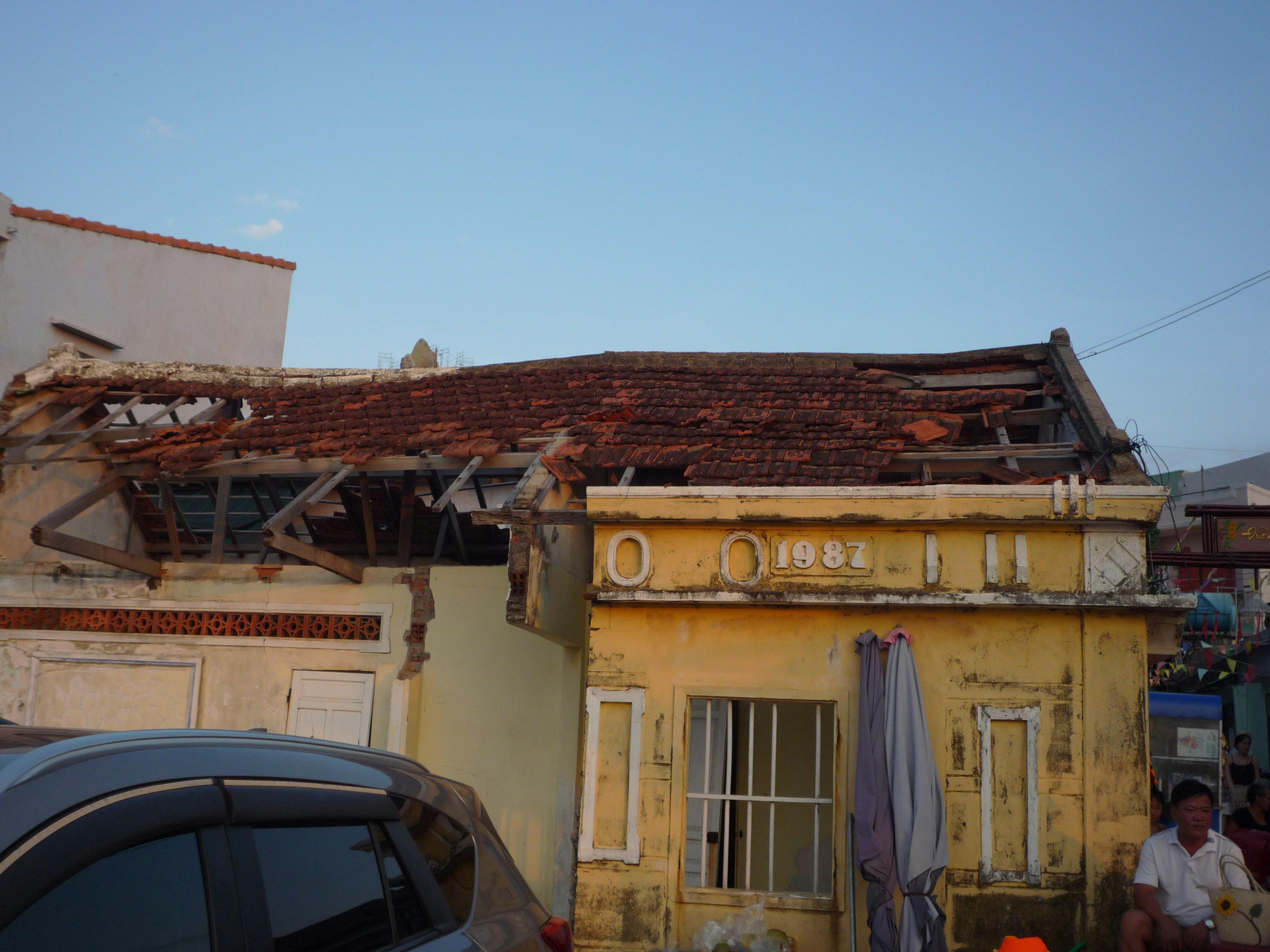 Sunlit Yellow Facade under a Collapsed Roof