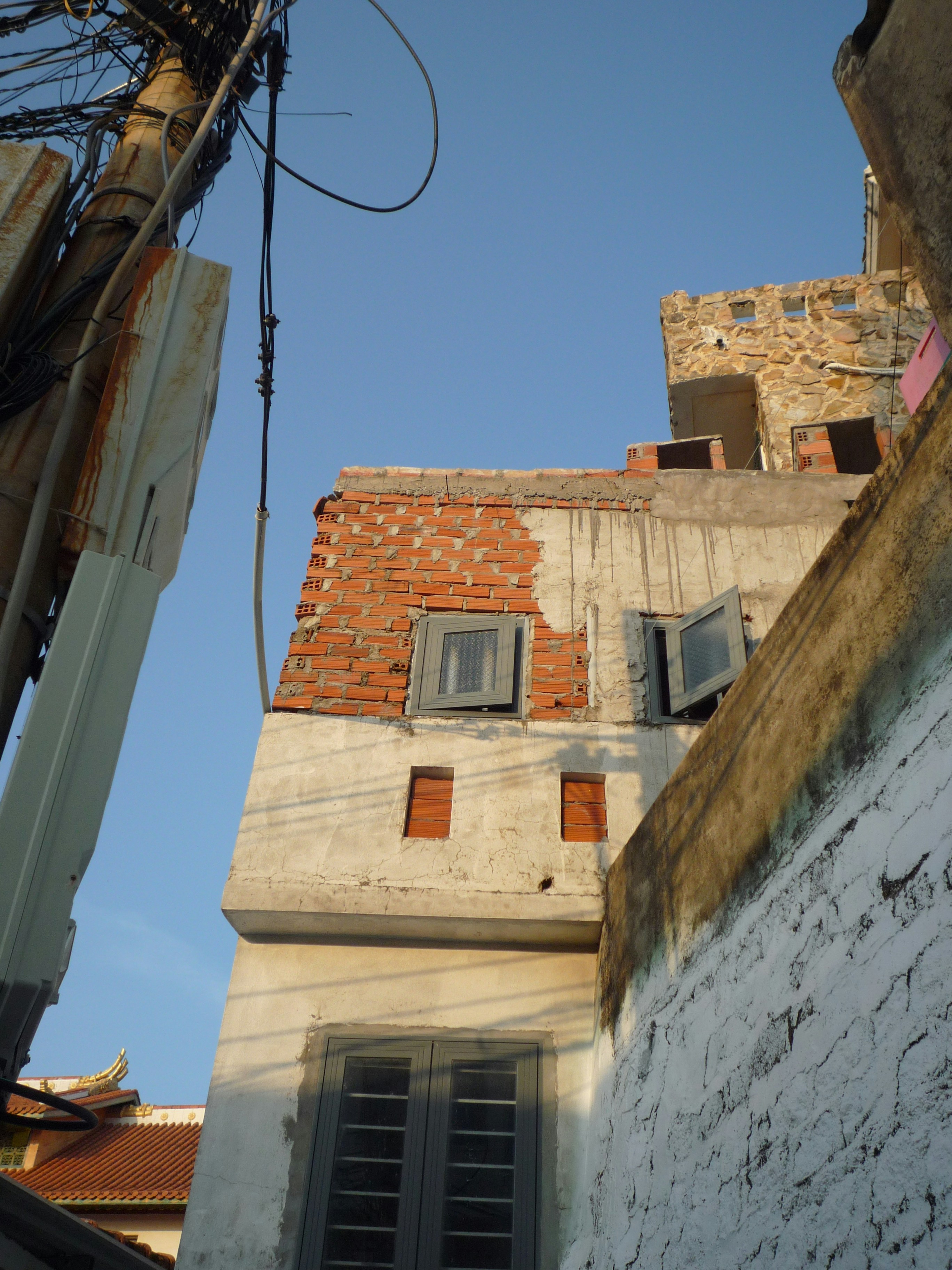 Vertical City Crux: Brick and Sky Between Walls