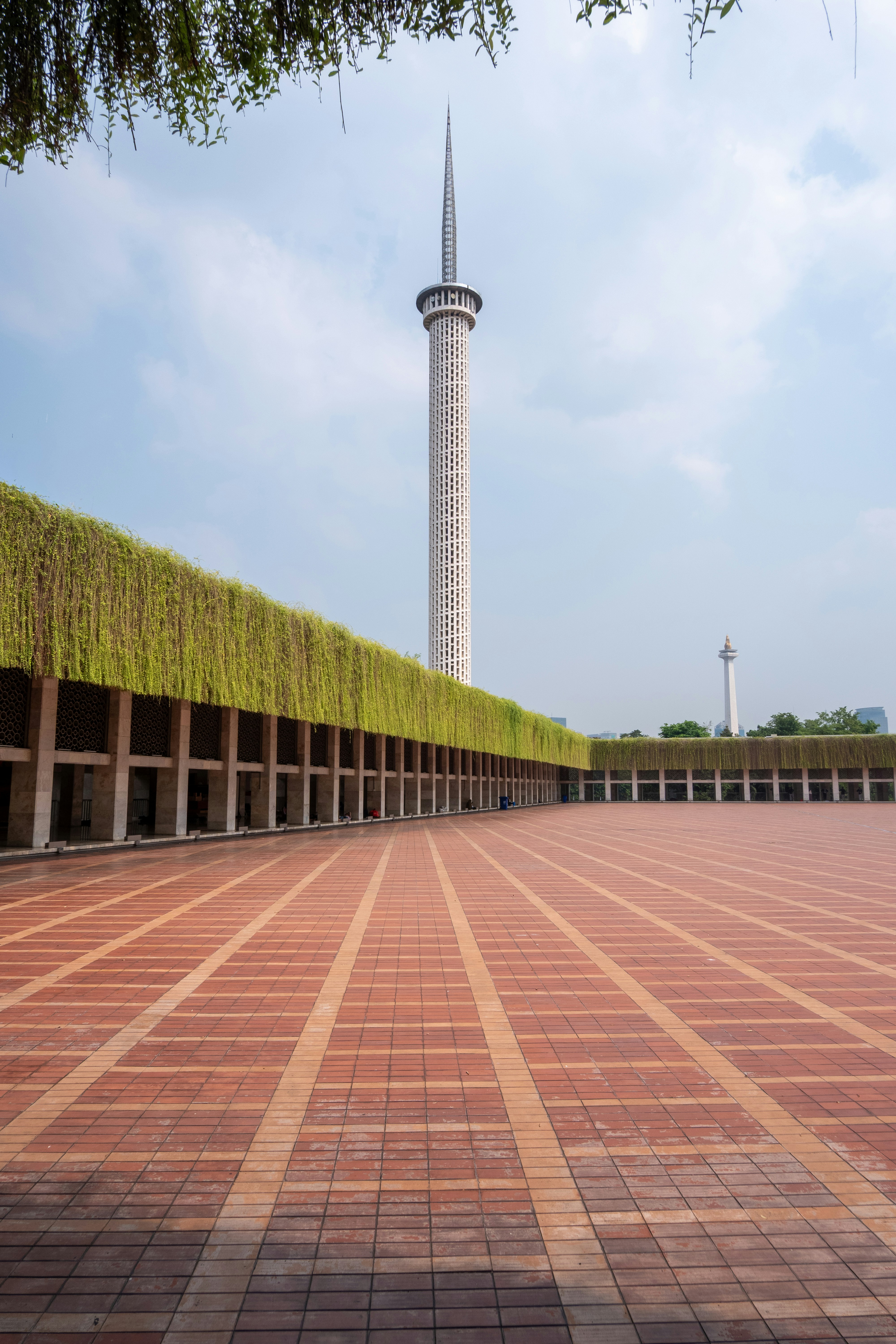 Vertical Spire Over a Terracotta Terrace