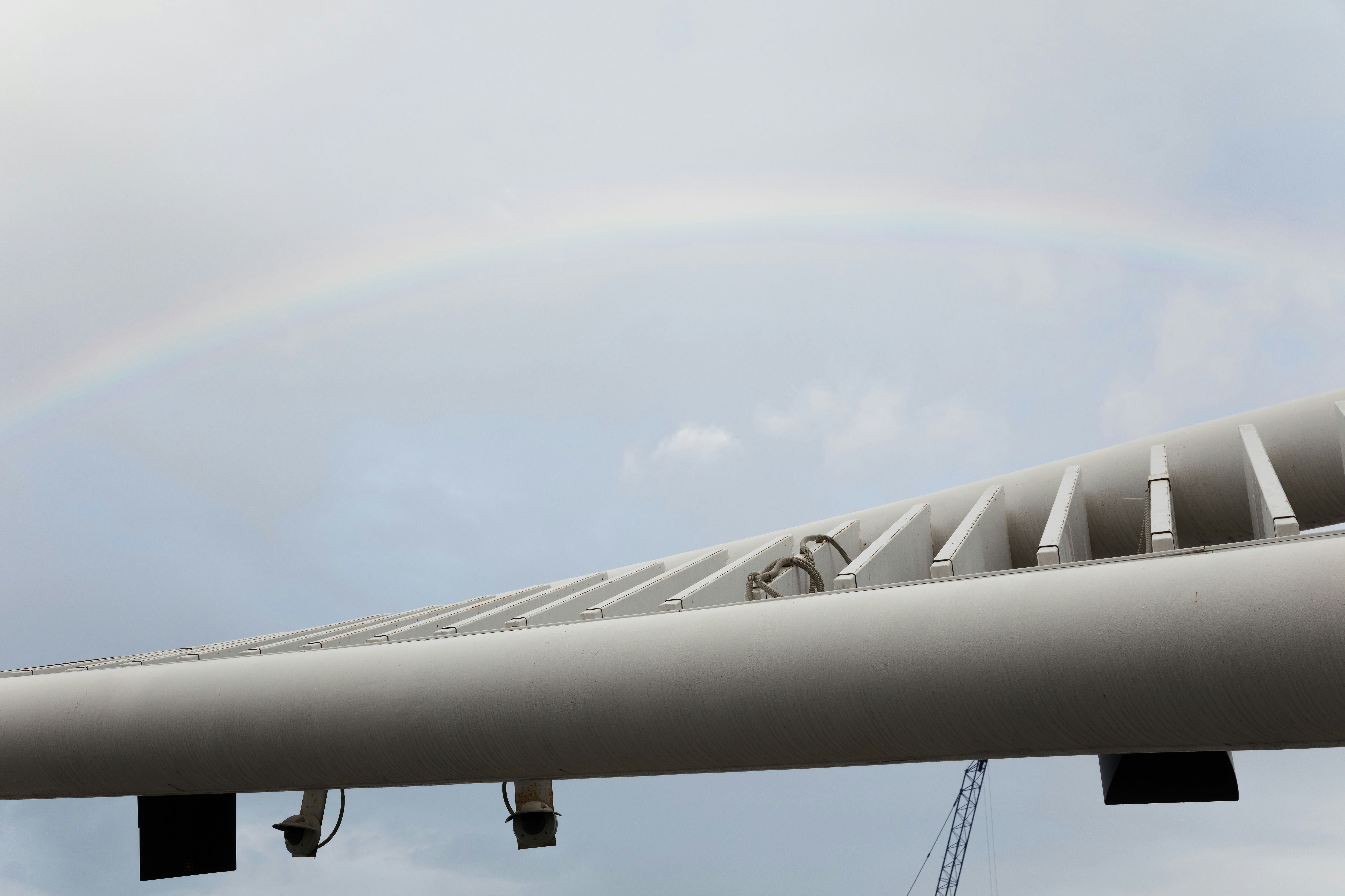 Arc in the Sky: A Silver Bridge Under a Fading Rainbow