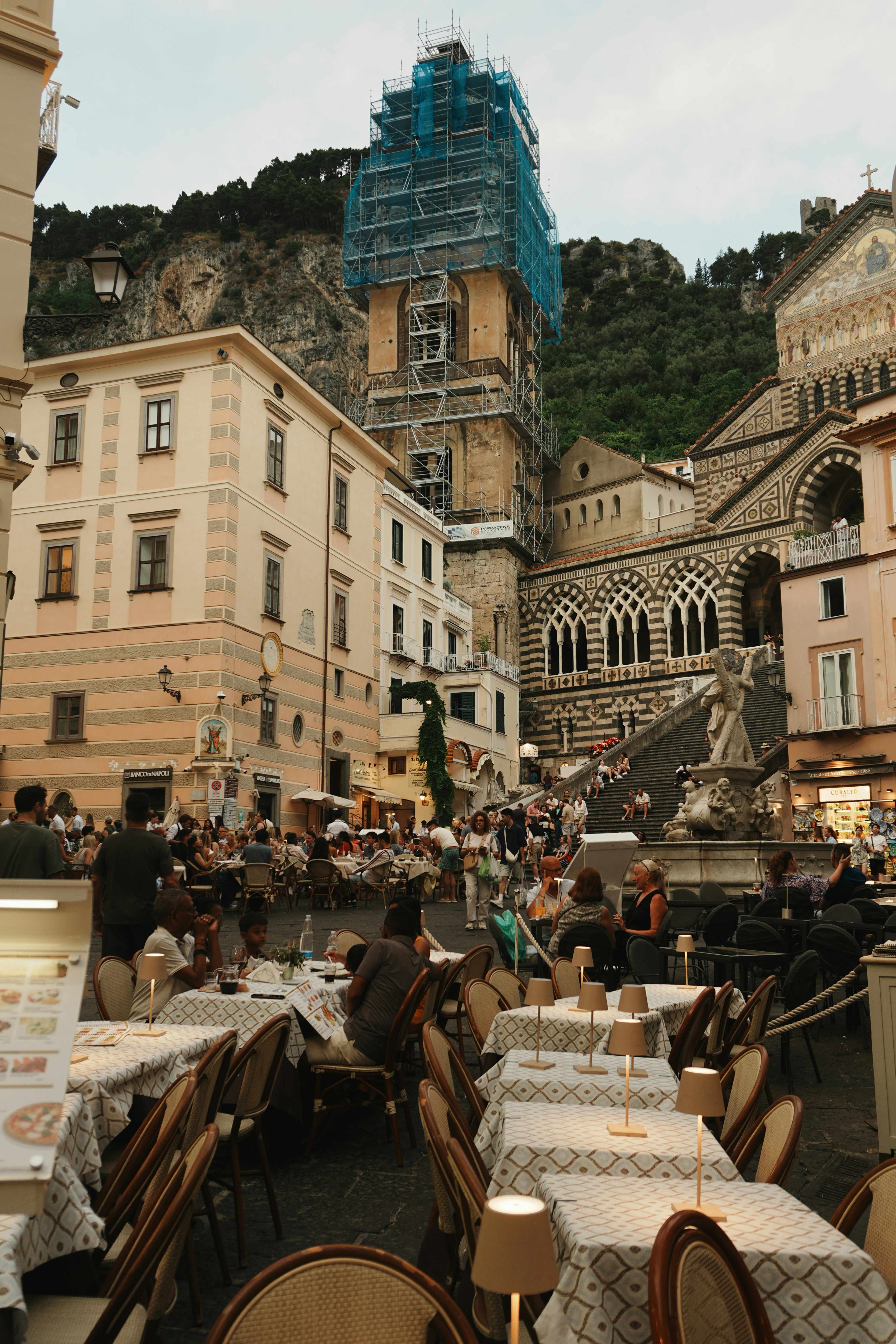 Cobbled Piazza Under Renovation: A Café-Filled Square Before the Cathedral Steps