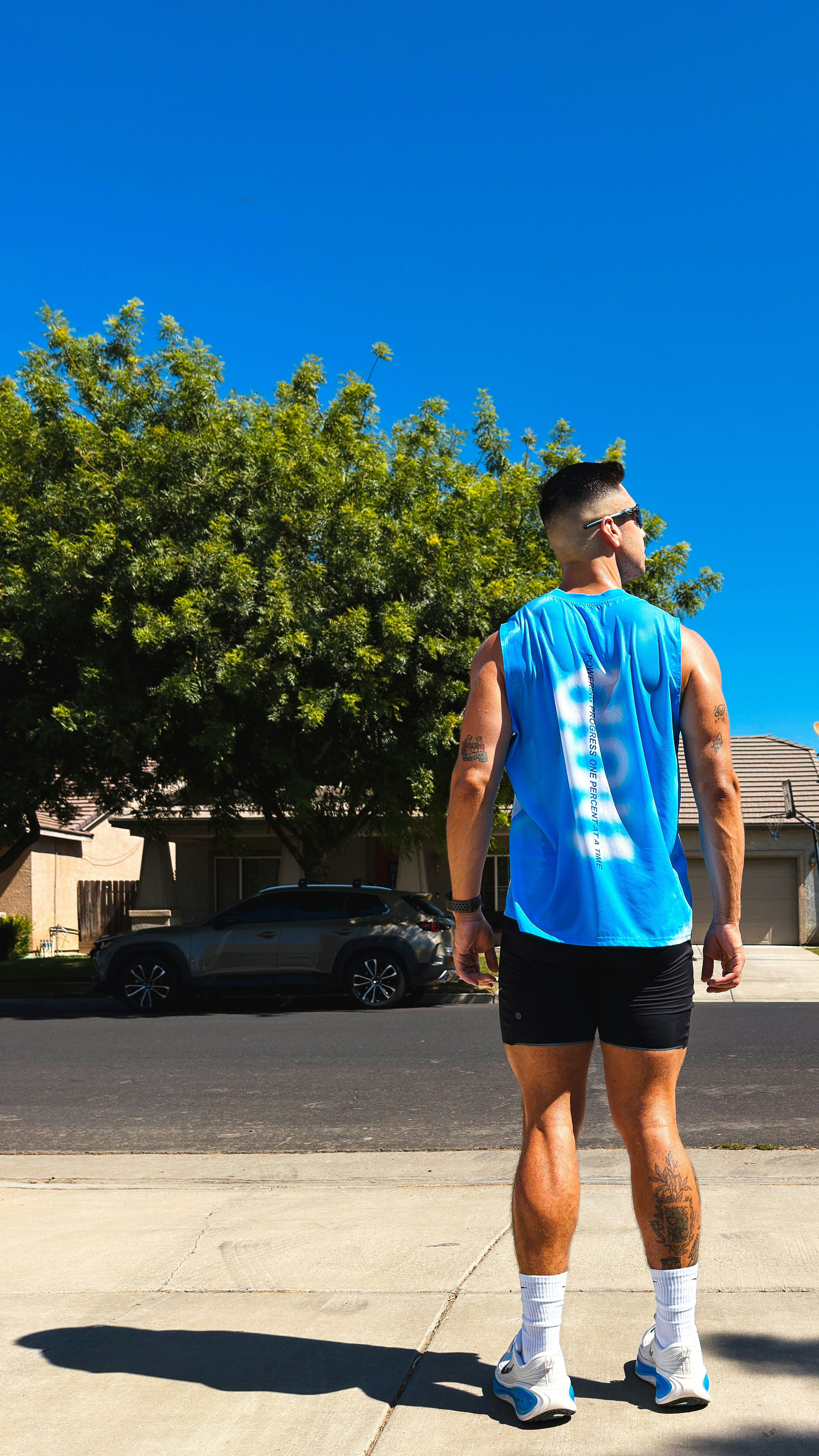 Runner in Blue: Stride Across a Sunny Suburban Canvas