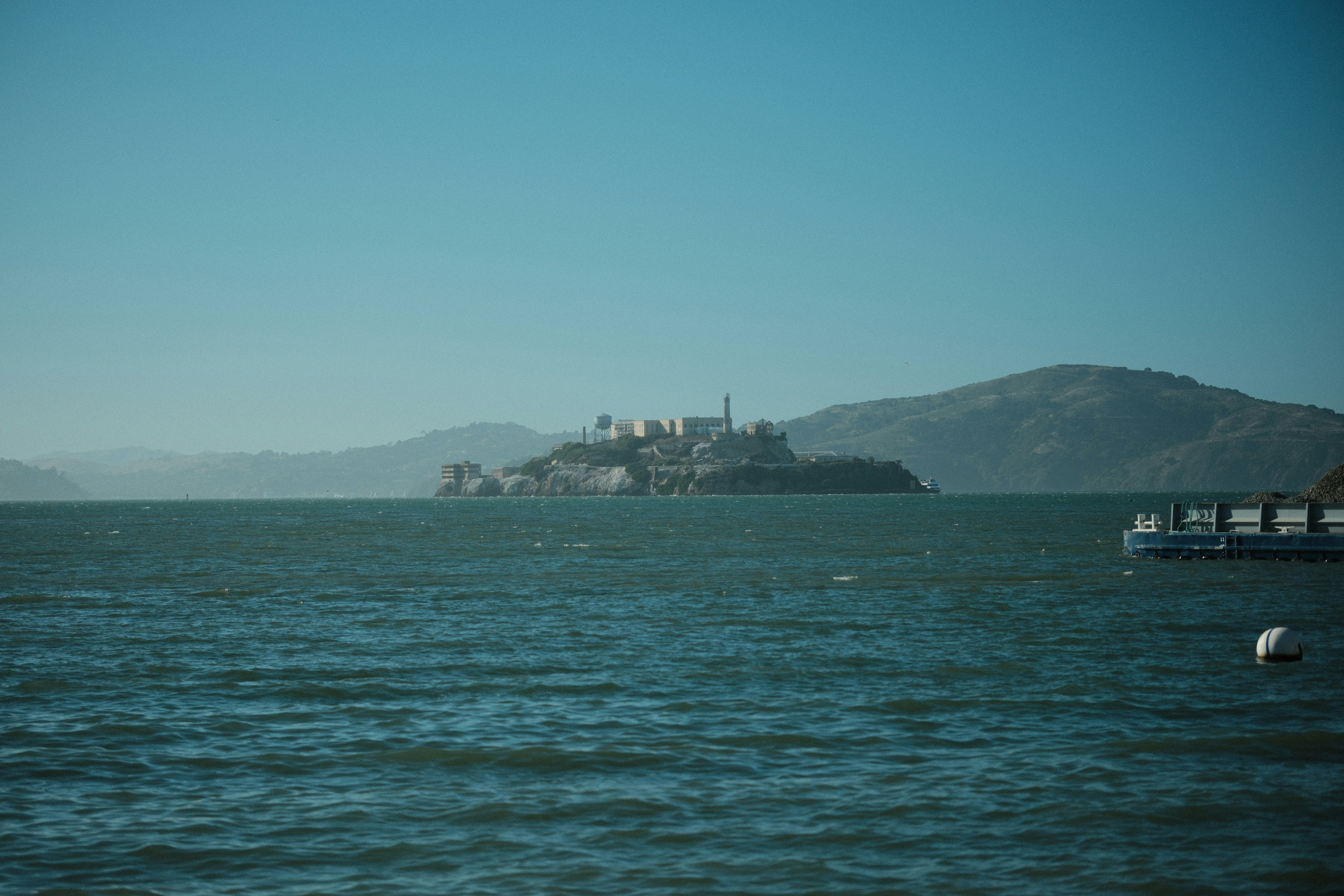 Silhouette Fortress: A distant island castle hovering over calm blue sea