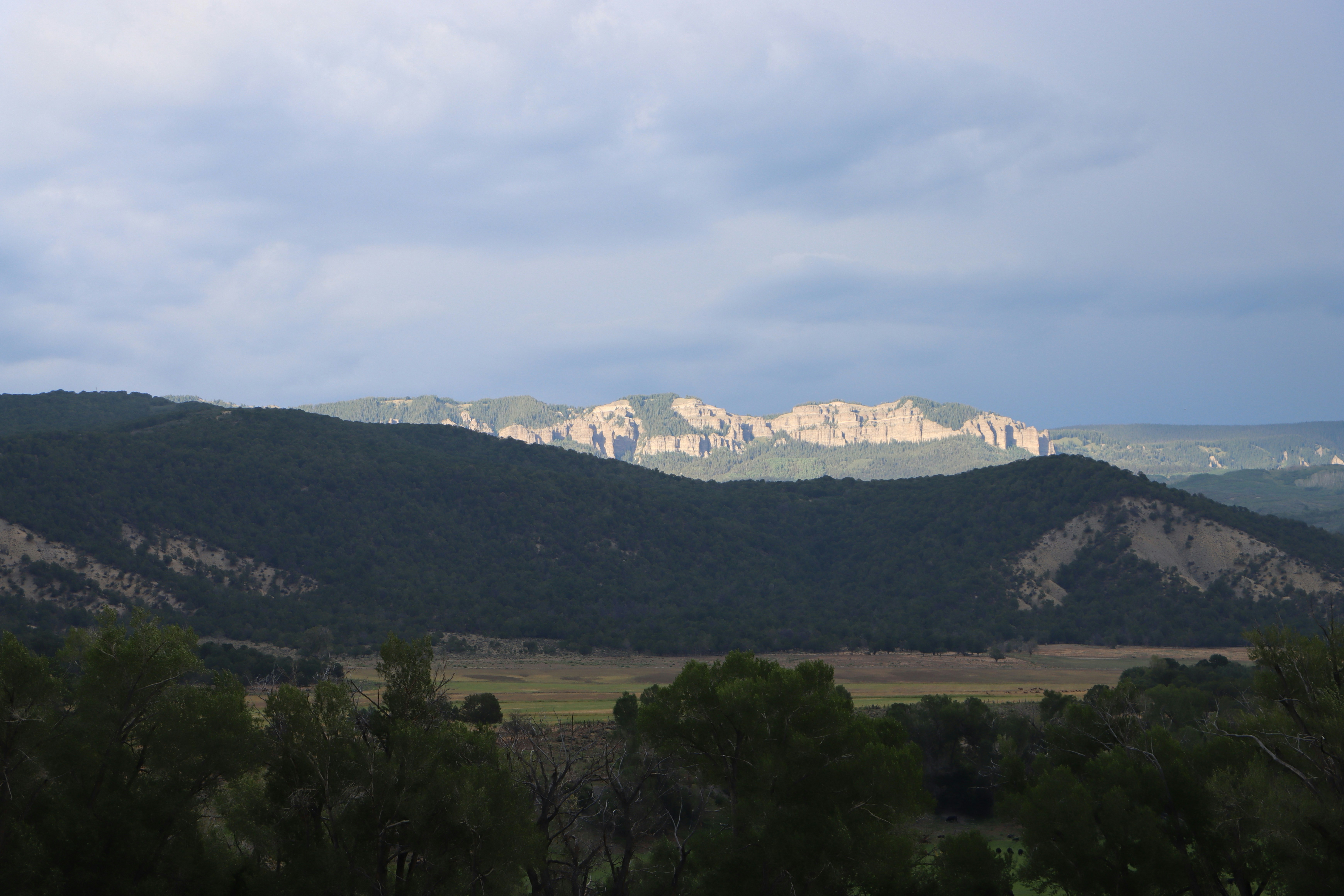 Sunlit Mesa Ridge Anchored by shadowed Foothills
