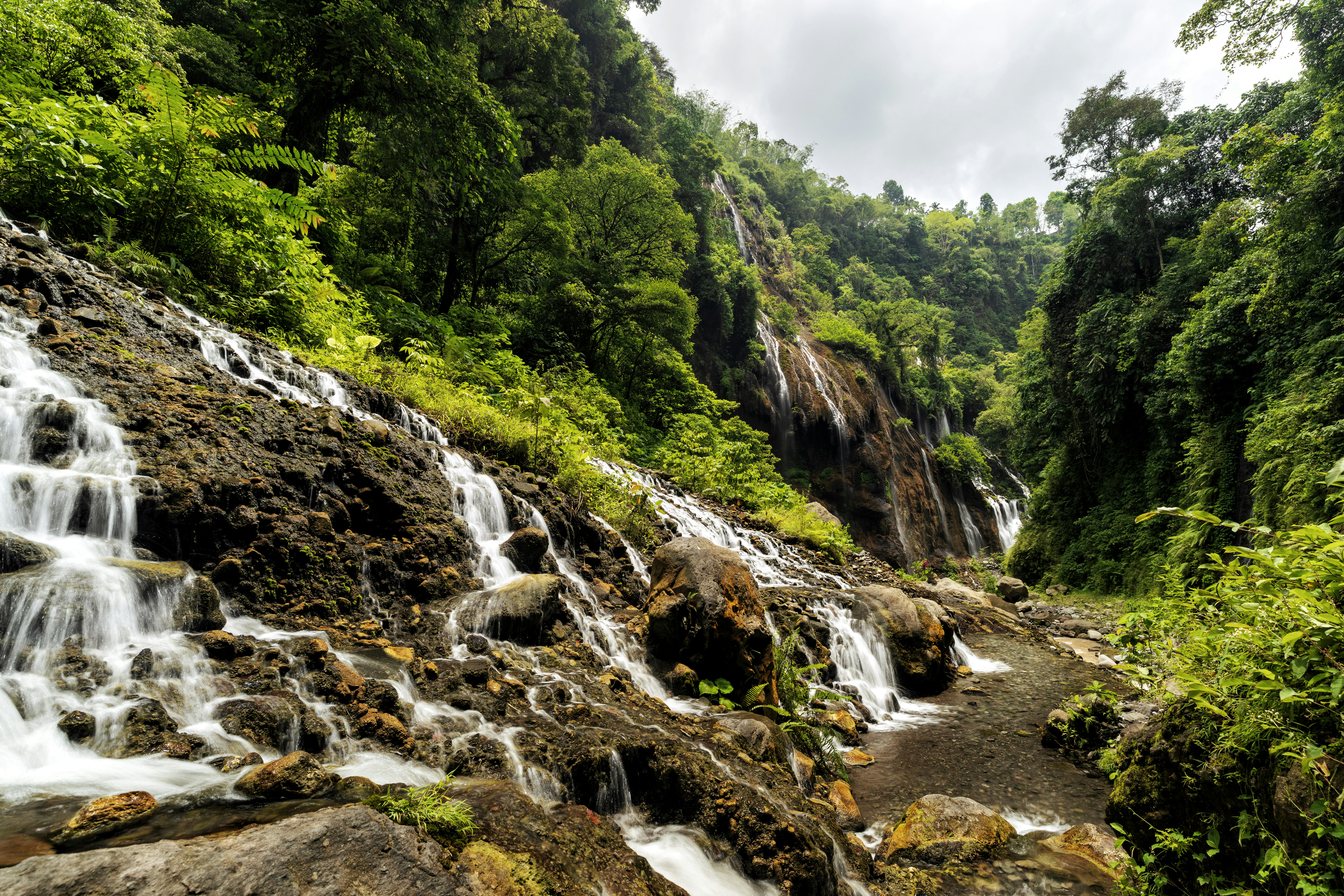 Whispering Cascades Through Emerald Cliffs