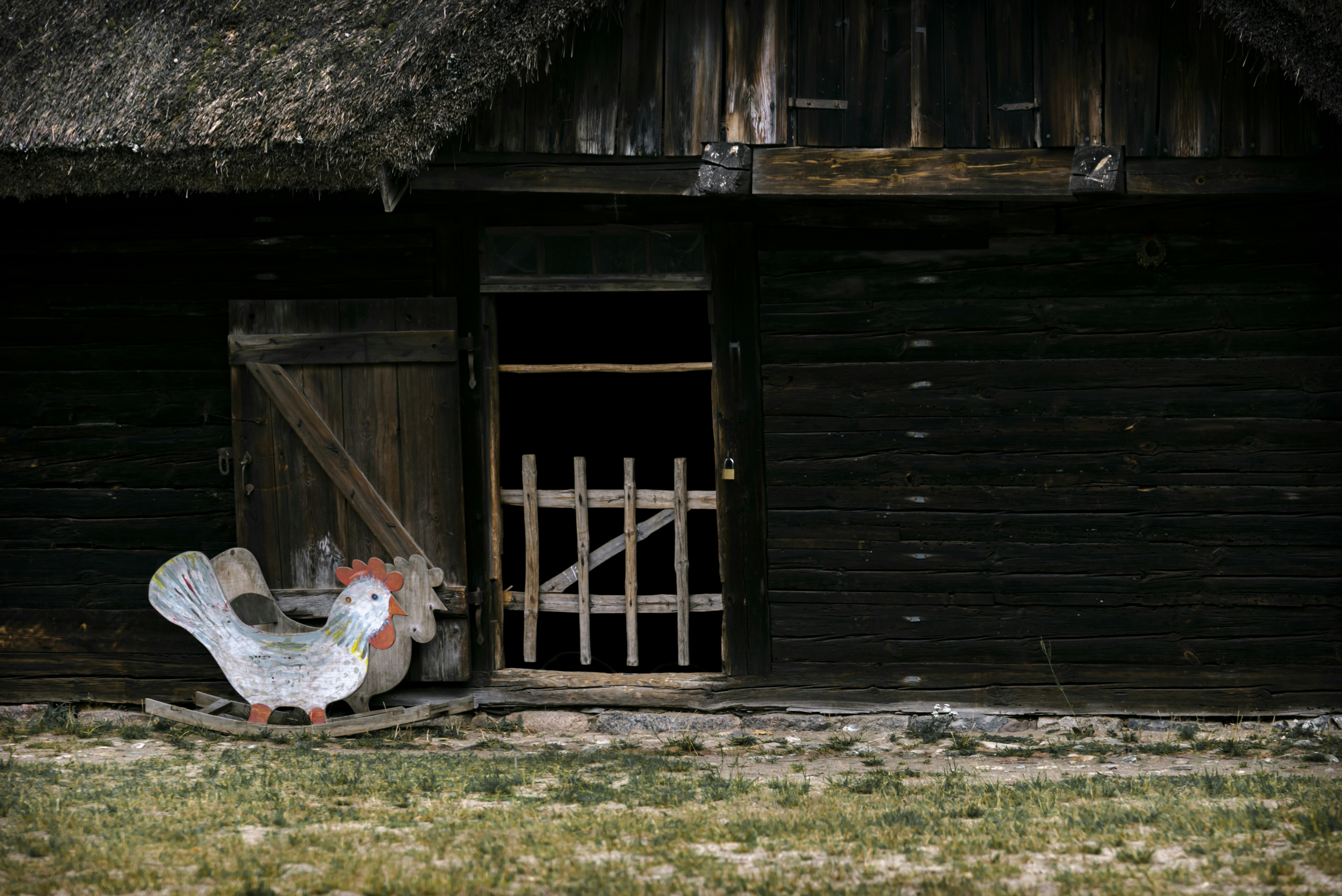 Wooden Barn Doorframe with Cardboard Chicken Silhouette at Ground Level