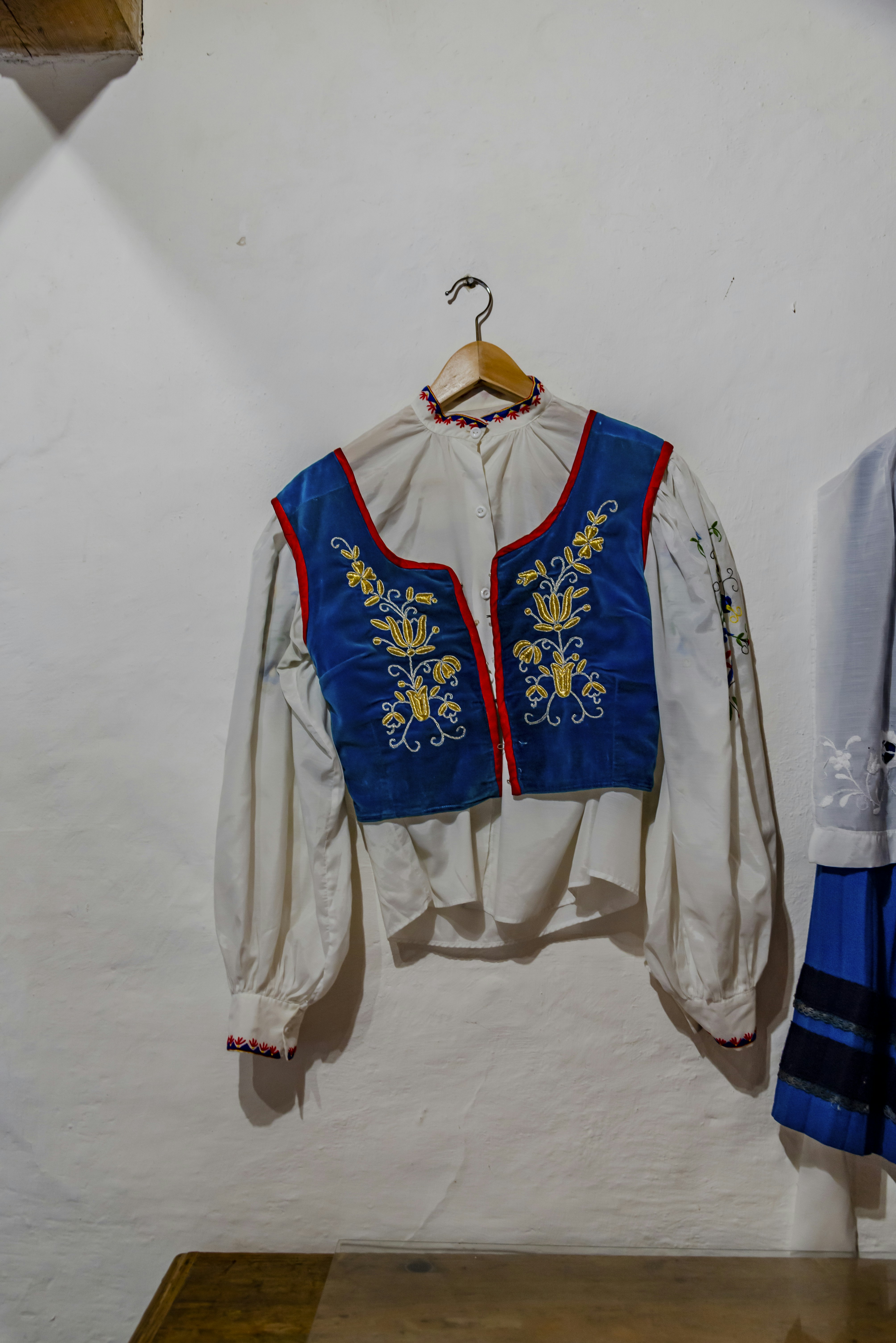 Embroidered Blue Vest Draped over a Traditional Blouse