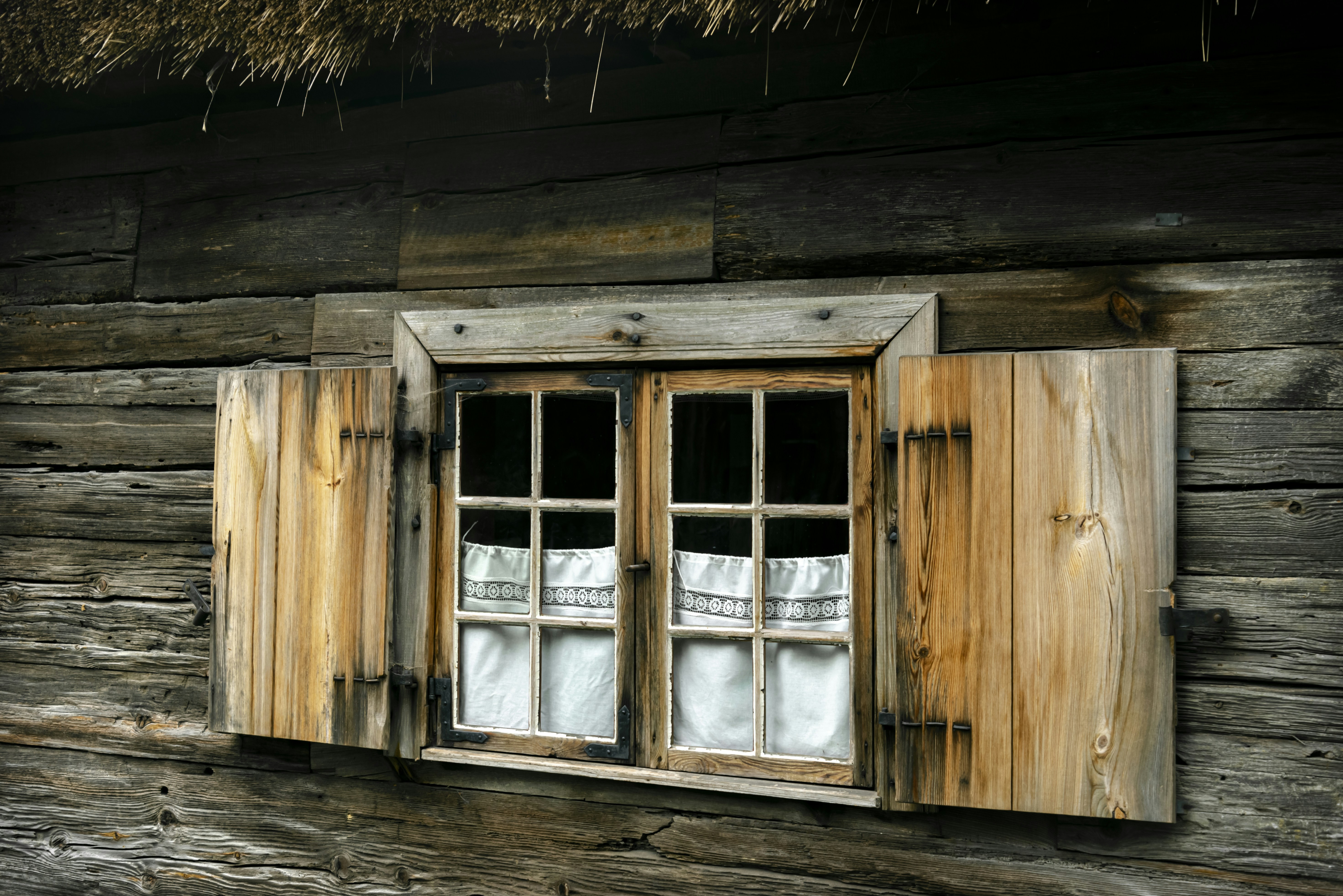 Weathered Window at the Edge of a Wooden Cabin