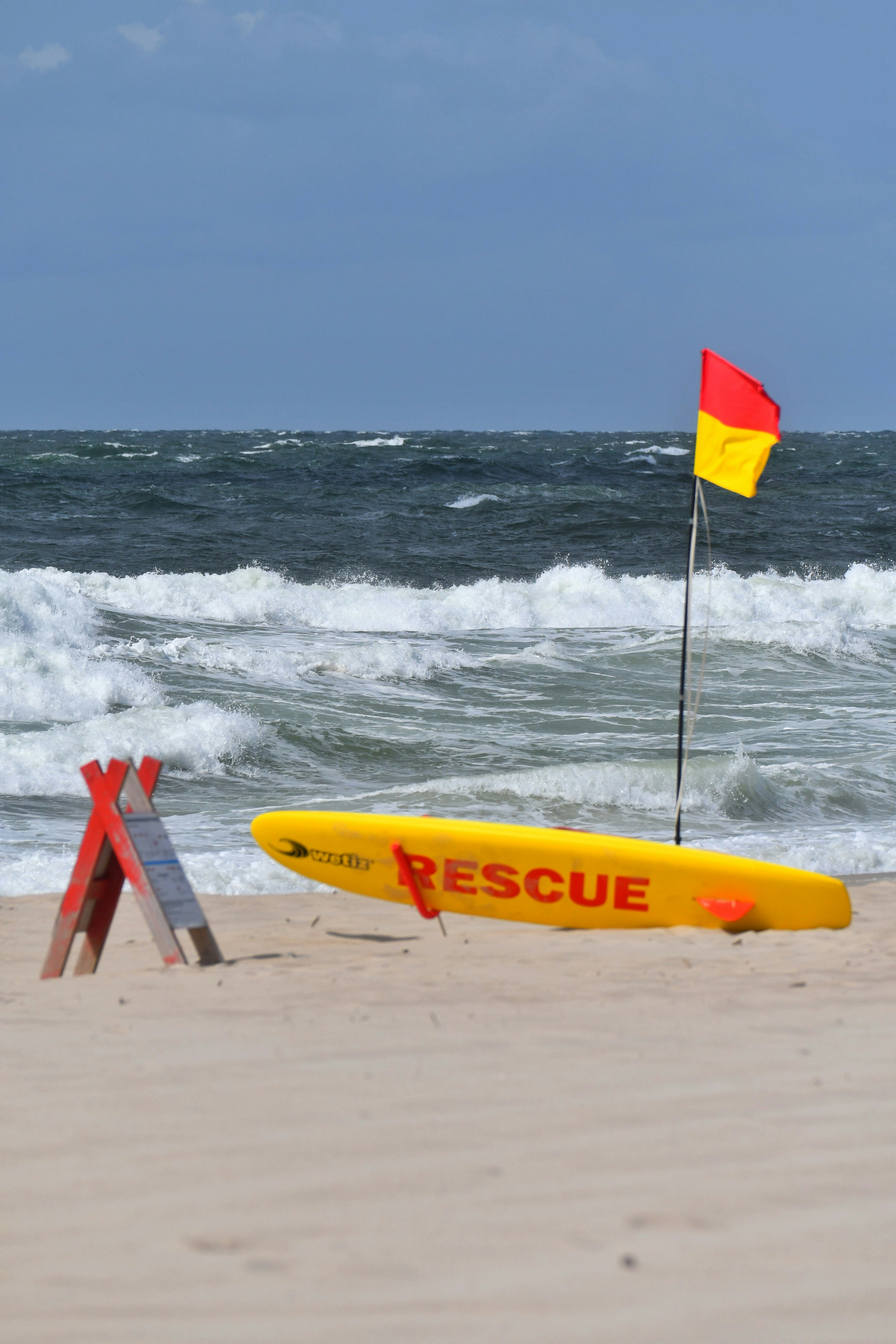 Rescue Gear on the Quiet Shore: A Surf Flag and Board Rest