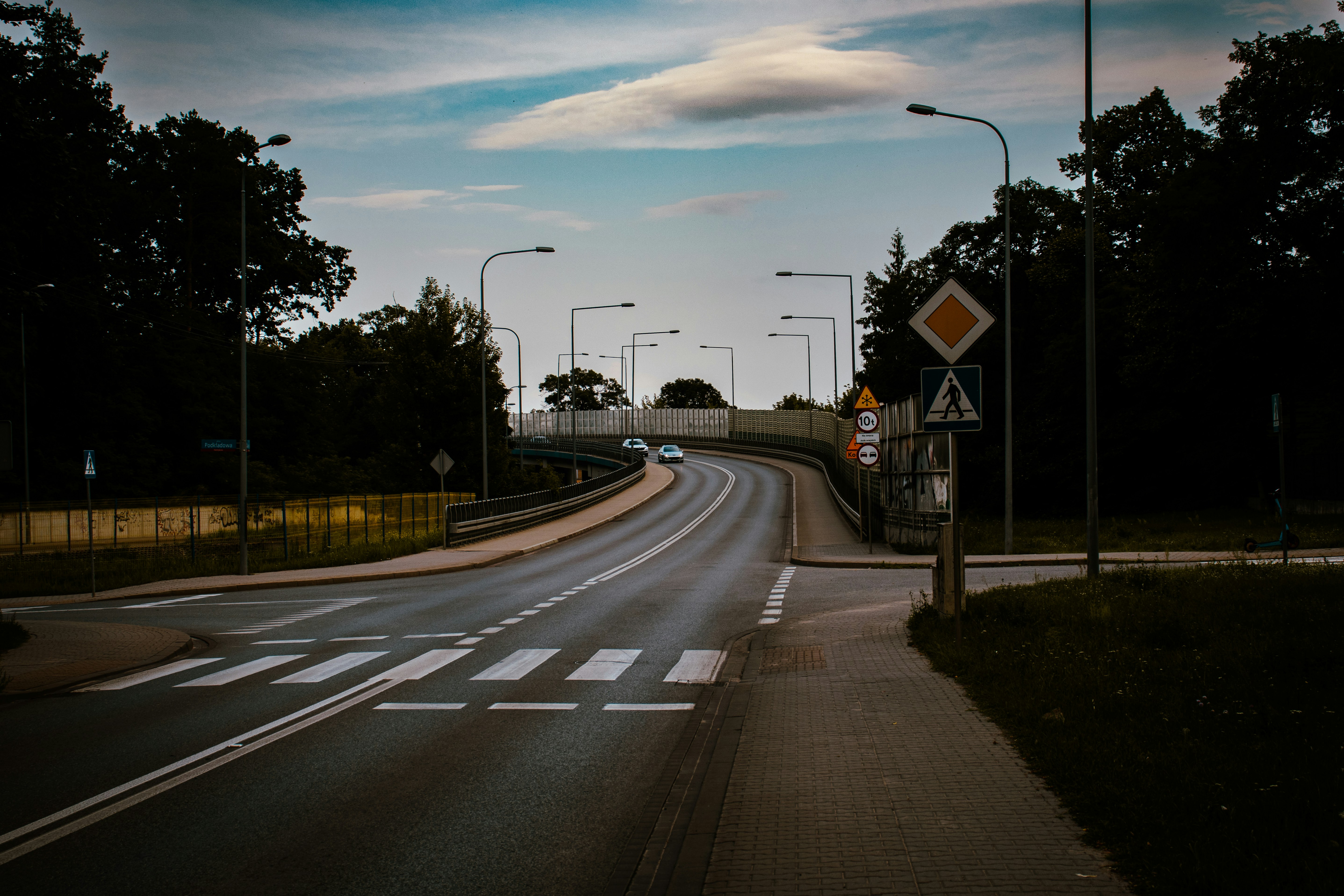 Urban Curve: A Quiet Drive Under Rising Streetlights