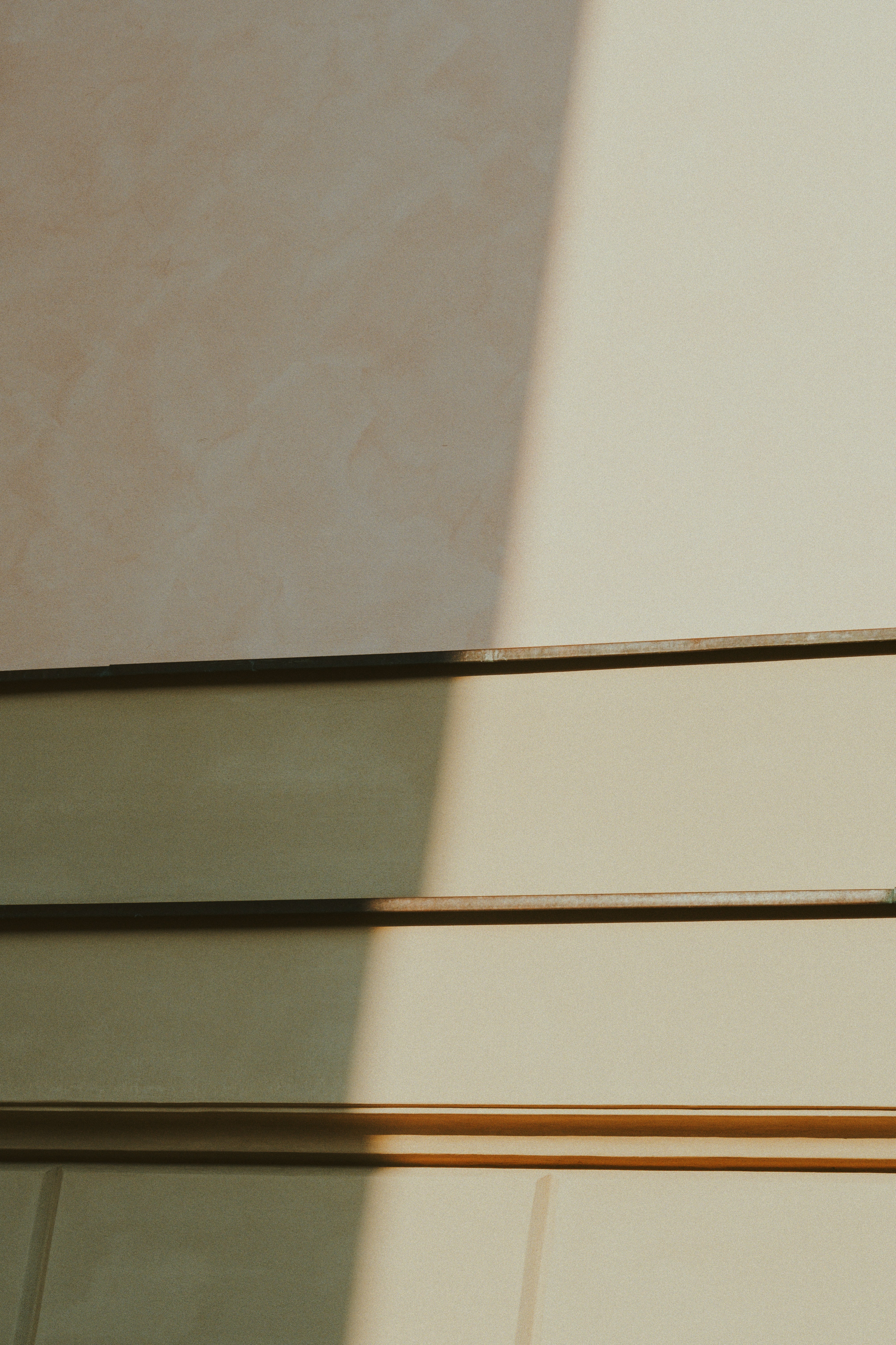 Shadowed seam: architectural light slicing across layered panels