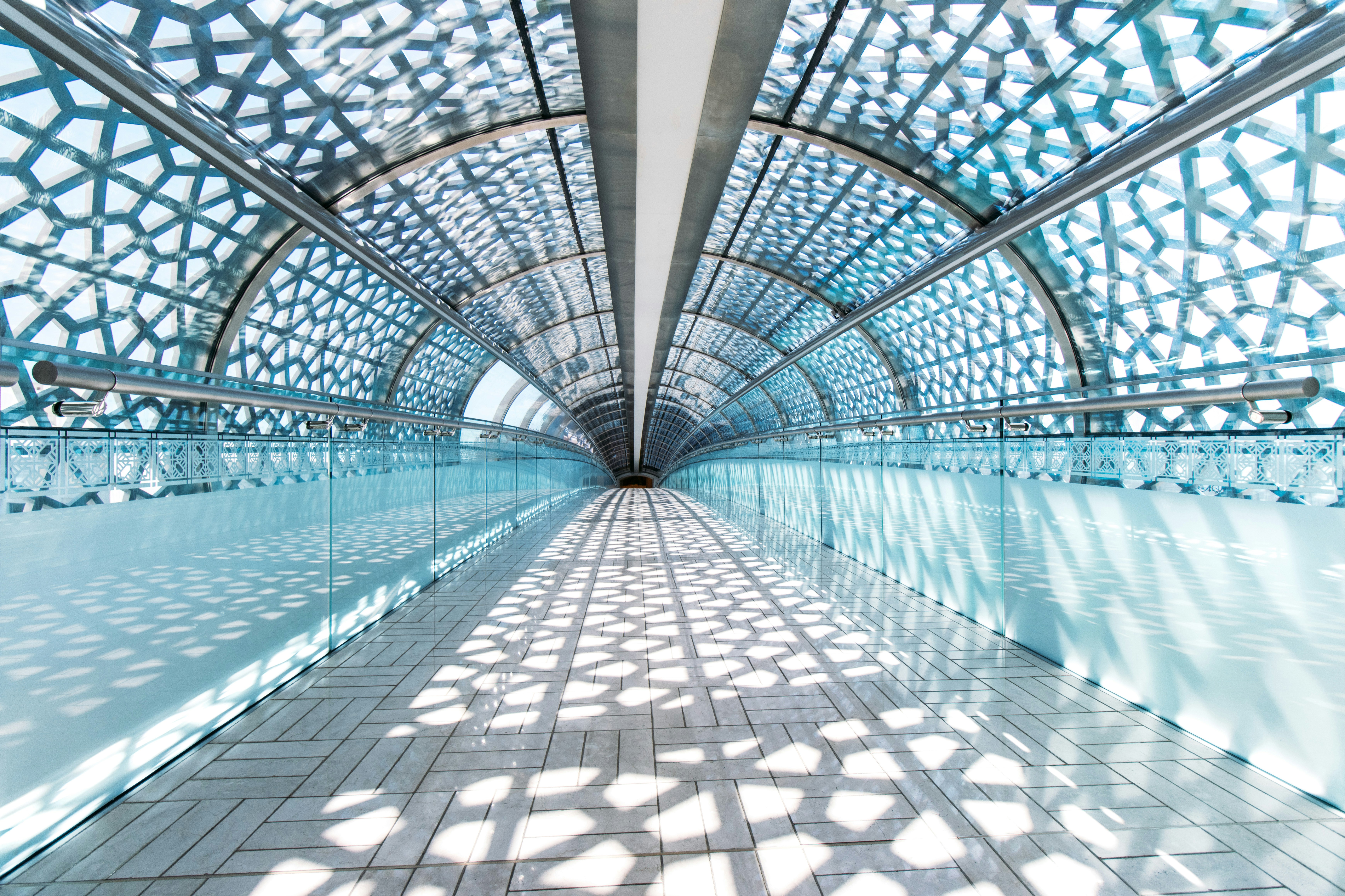 Cobalt Corridor: Light Filigree Through a Glass-Pattern Tunnel