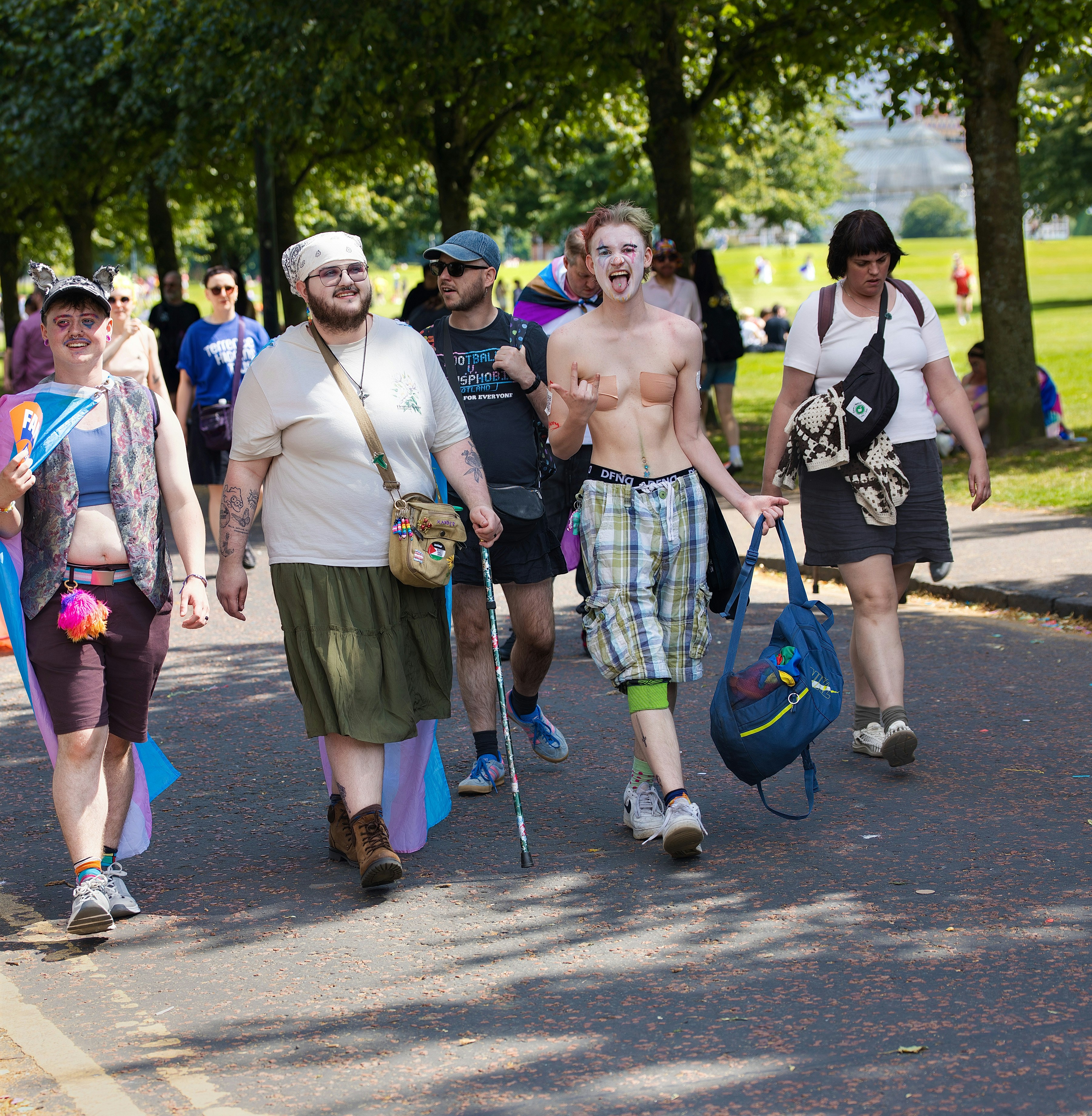Shout and Stride: A Bold Parade Entry on a Sunlit Park Walk
