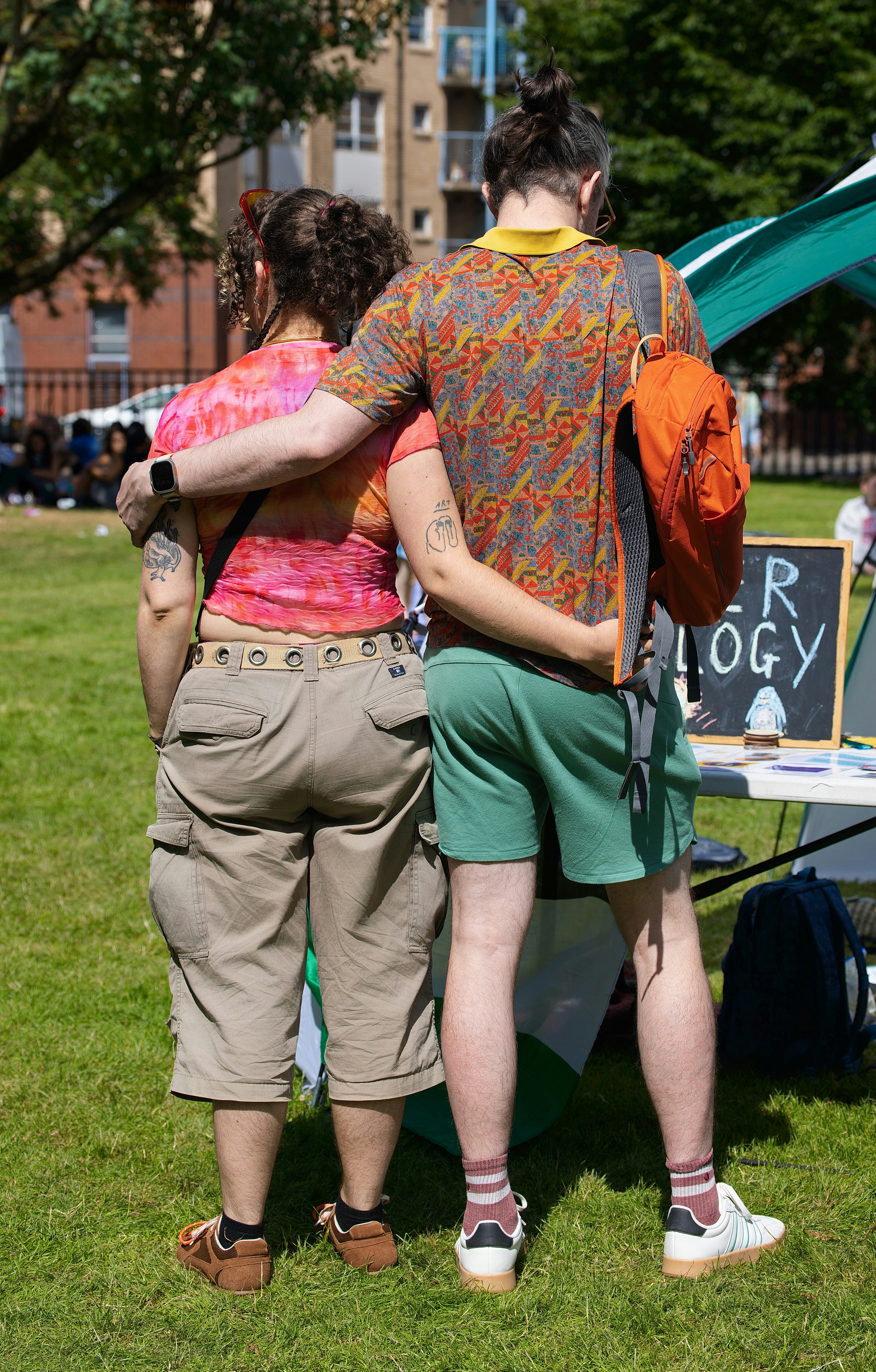 Together at the Park: A Shared Moment Beneath the Party Tent