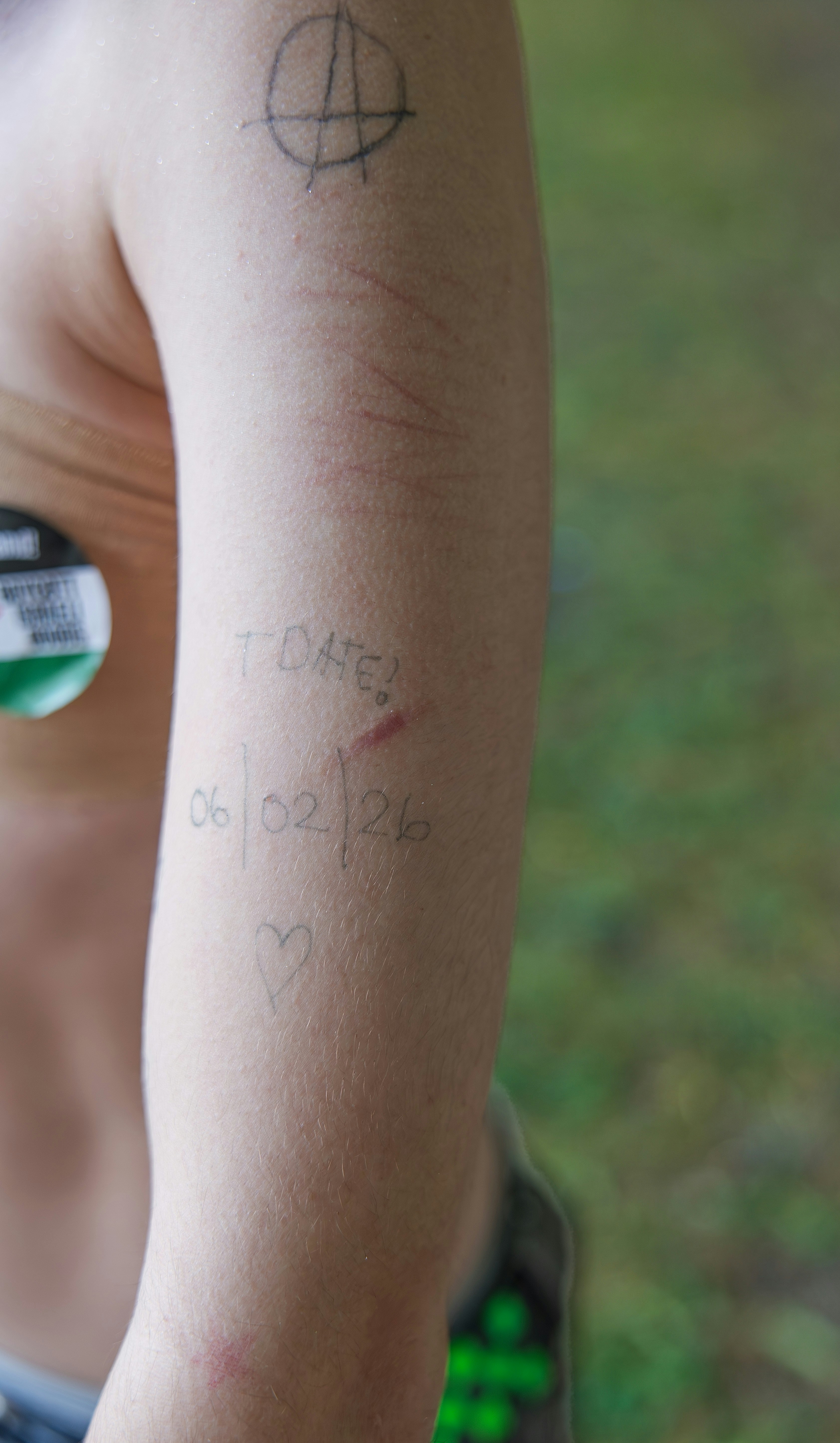 Tattooed Arm in Soft Focus: A Casual Portrait Study