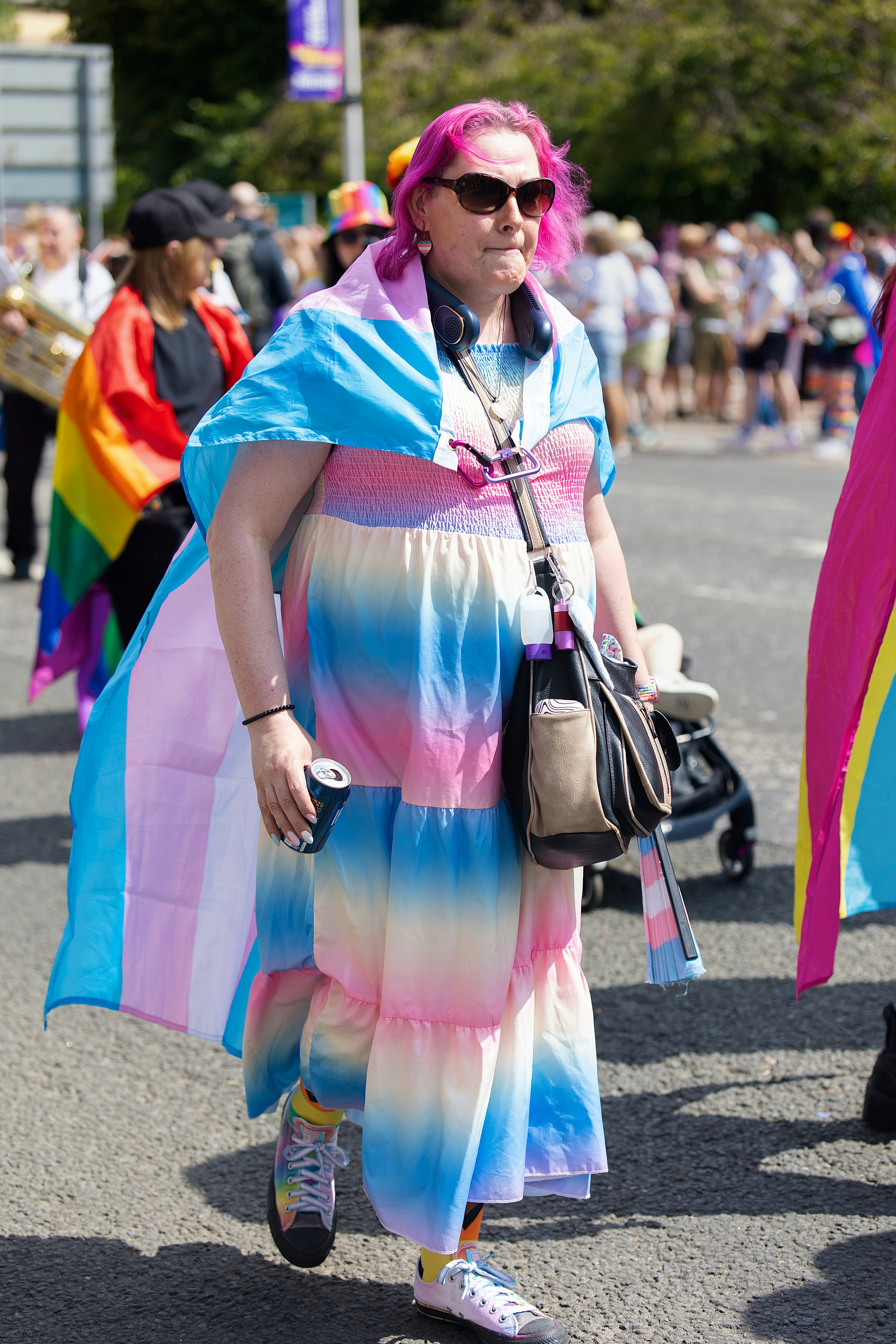 Rainbow Flag Bearer in Flowing Pastel Dress at Pride Parade