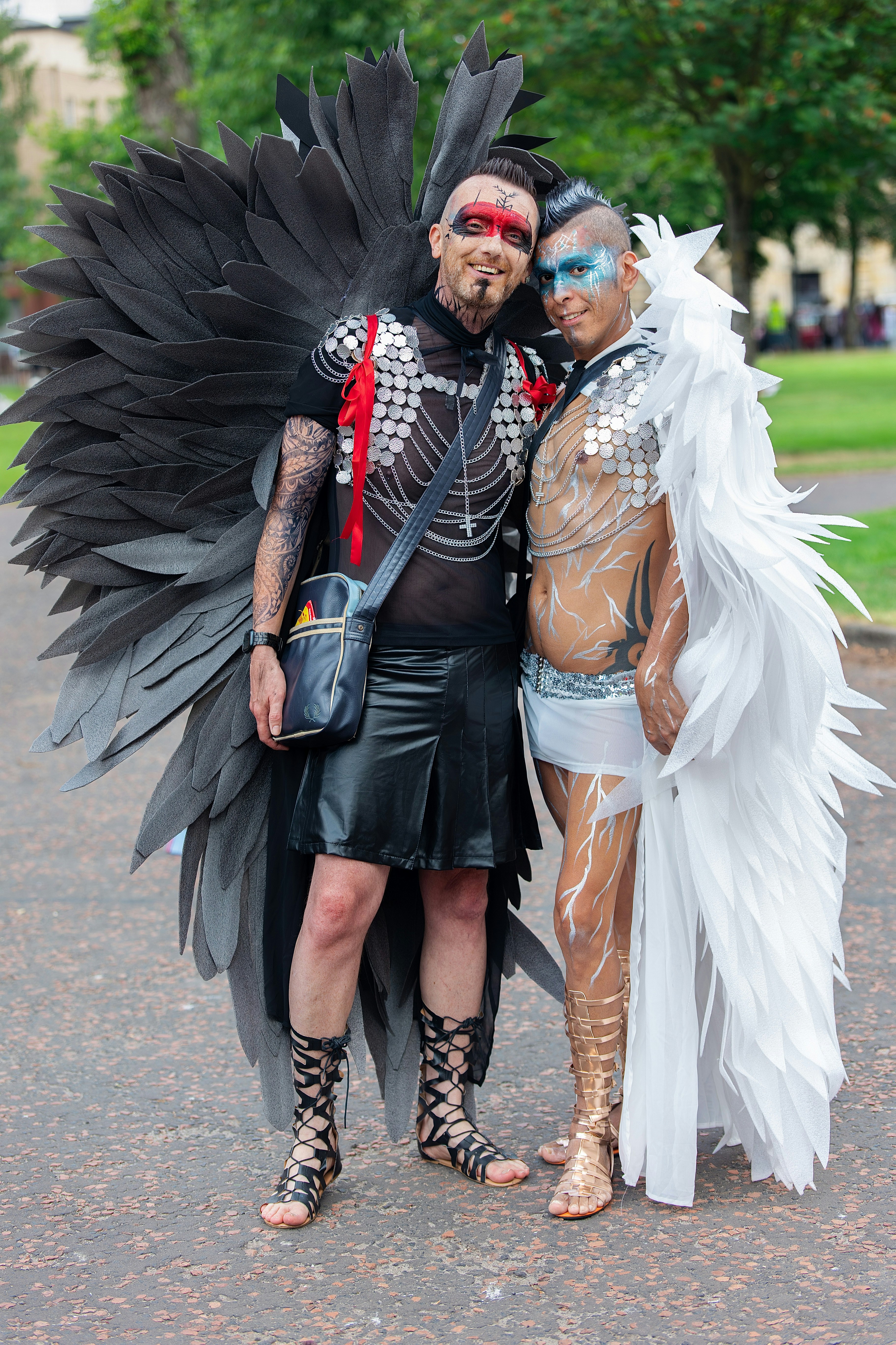 Wings of Costume: Twin Performers in Colorful Armor