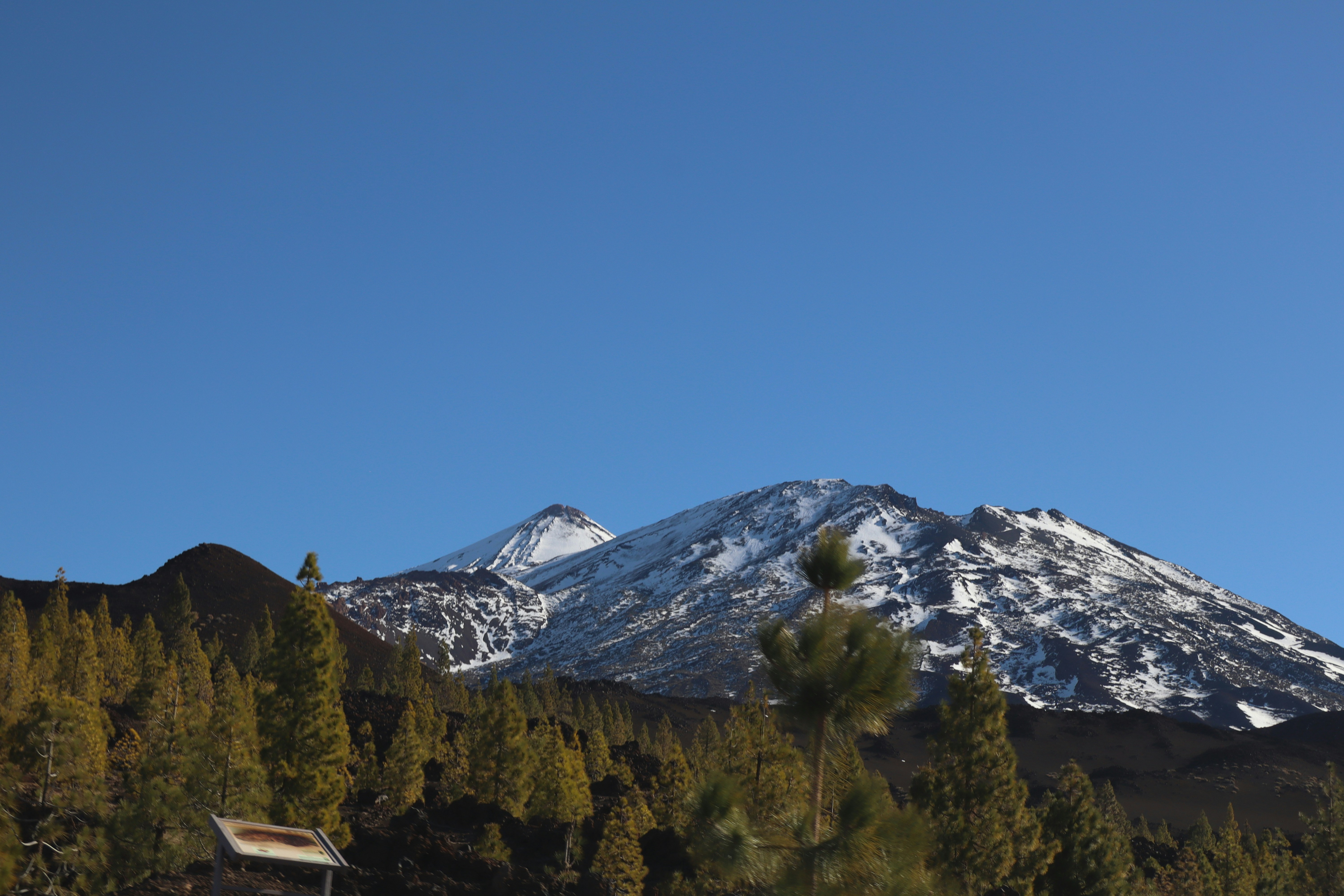 Snow-dusted ridge under a clear blue sky