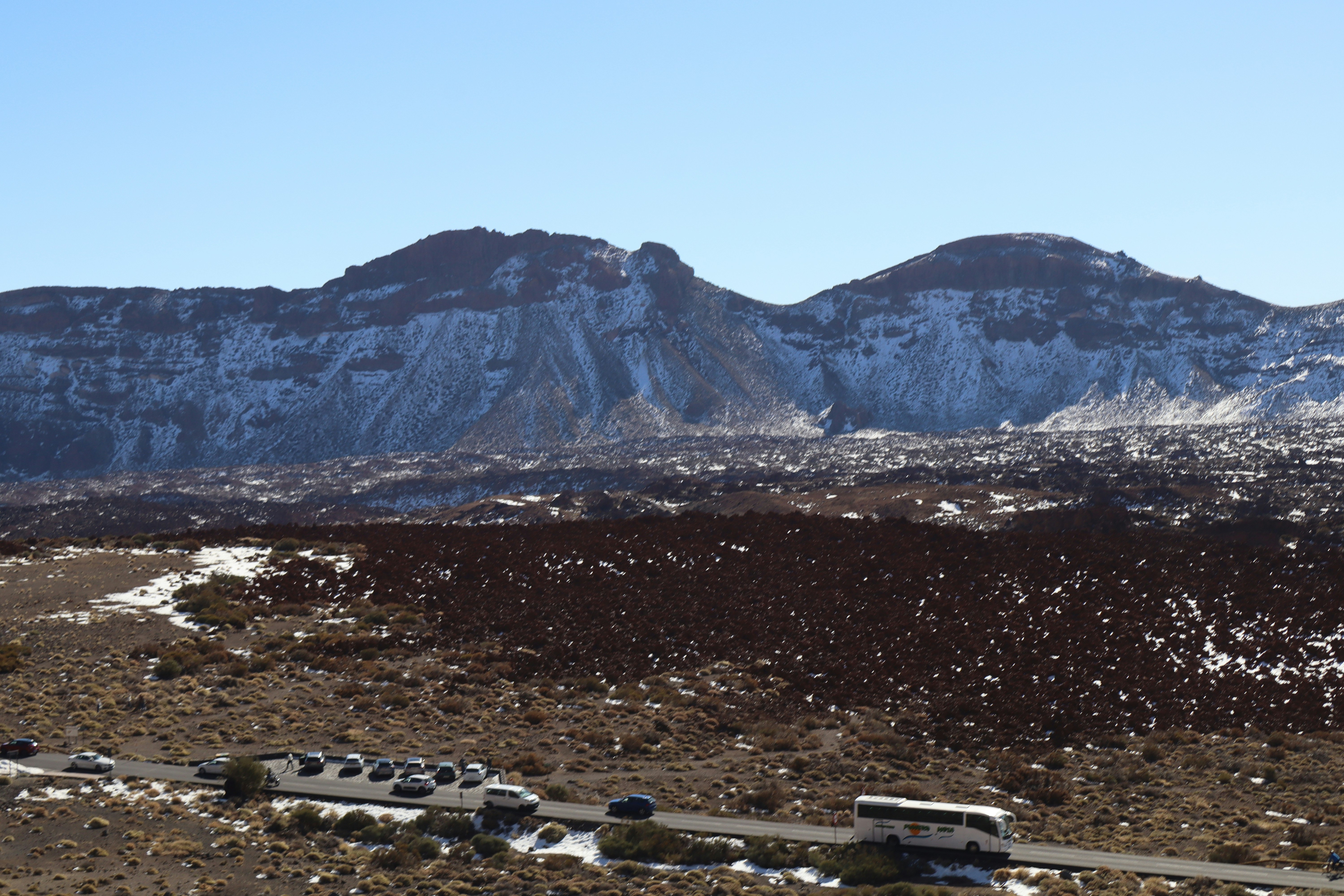 Rugged Rim Aerial: Snow-dusted mesas under a clear sky