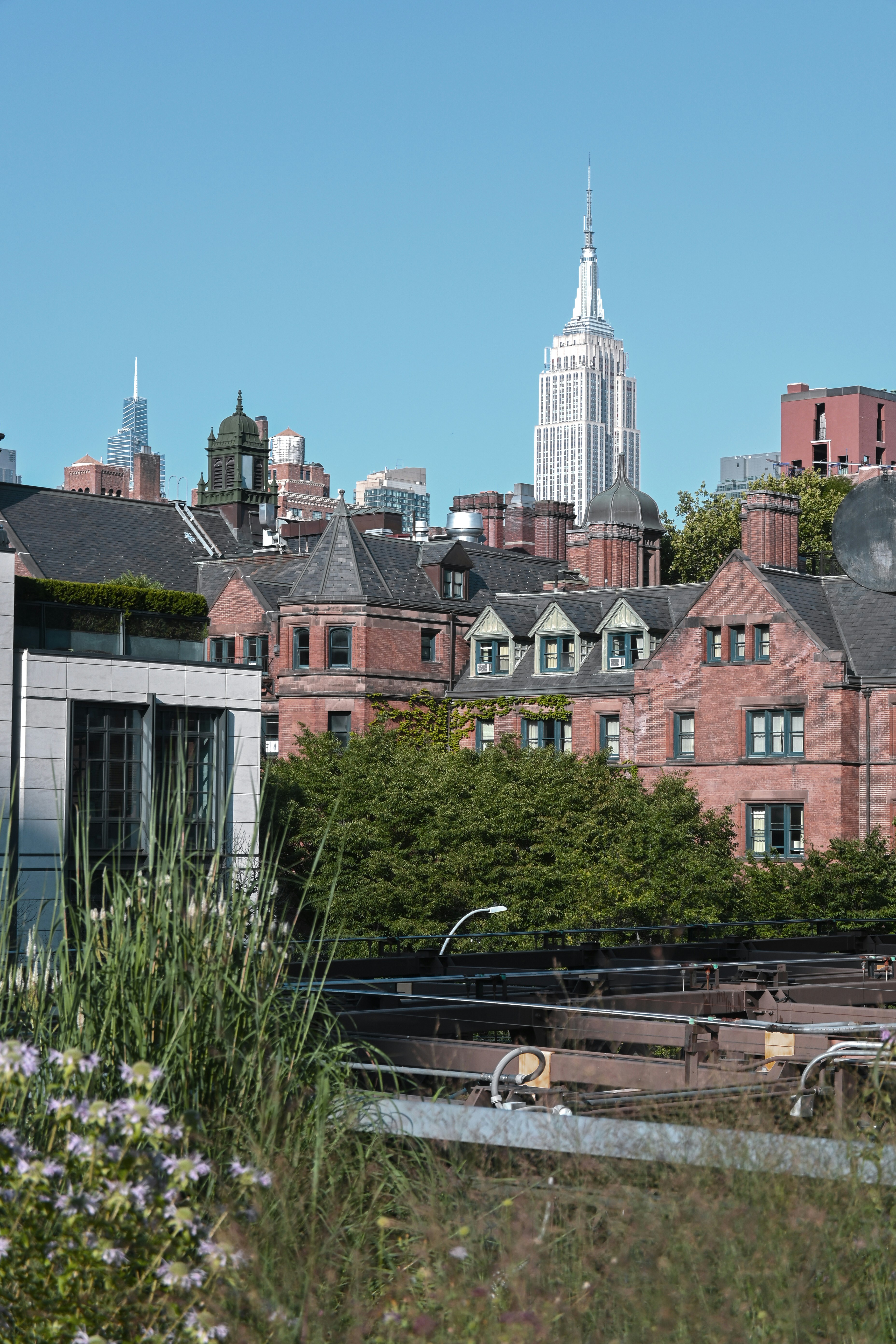 Skyline Threads: Empire State Peak Above Rooftop Reds