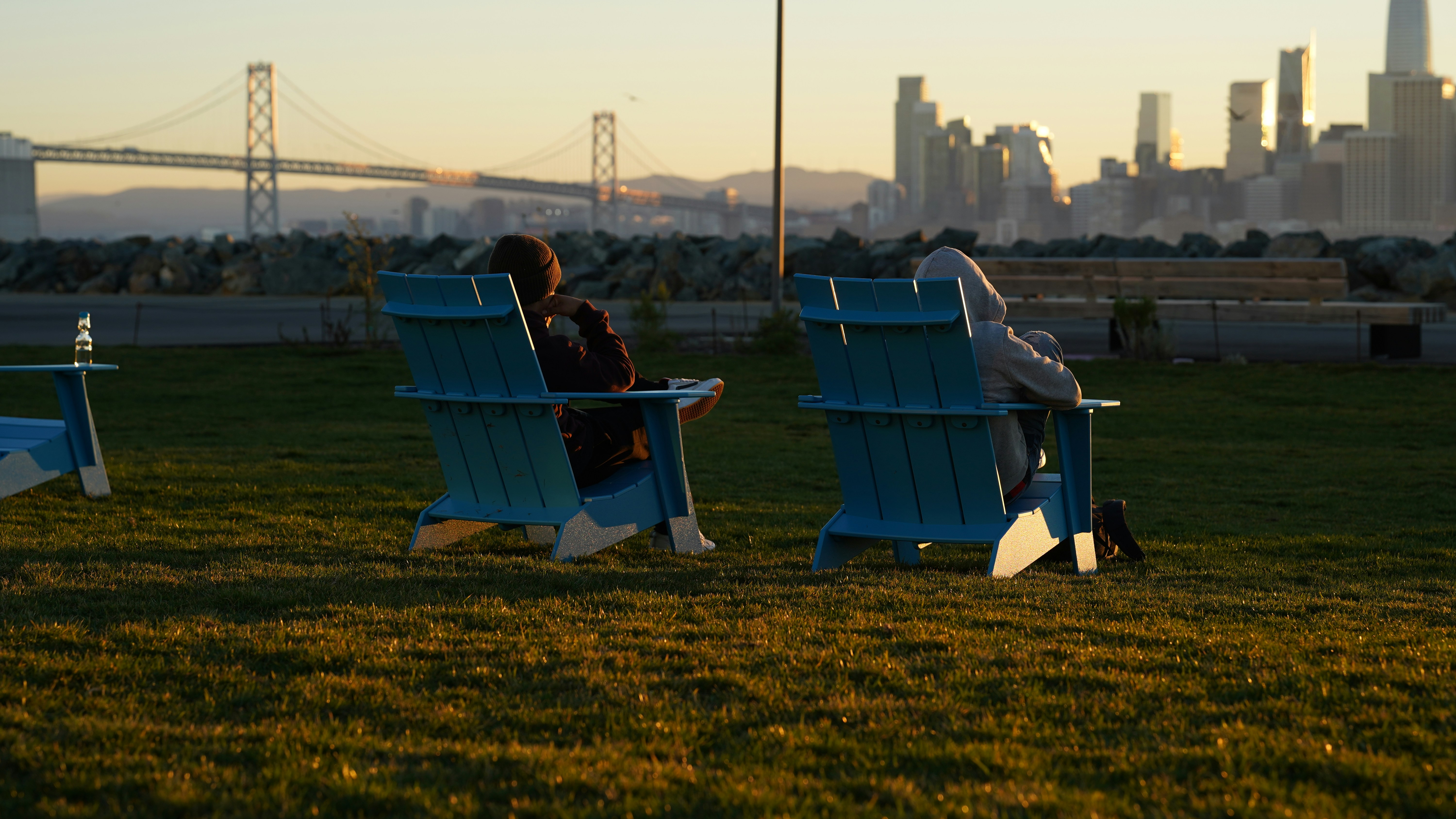Evening Quiet: Two Adirondack Chairs Beneath a City Skyline