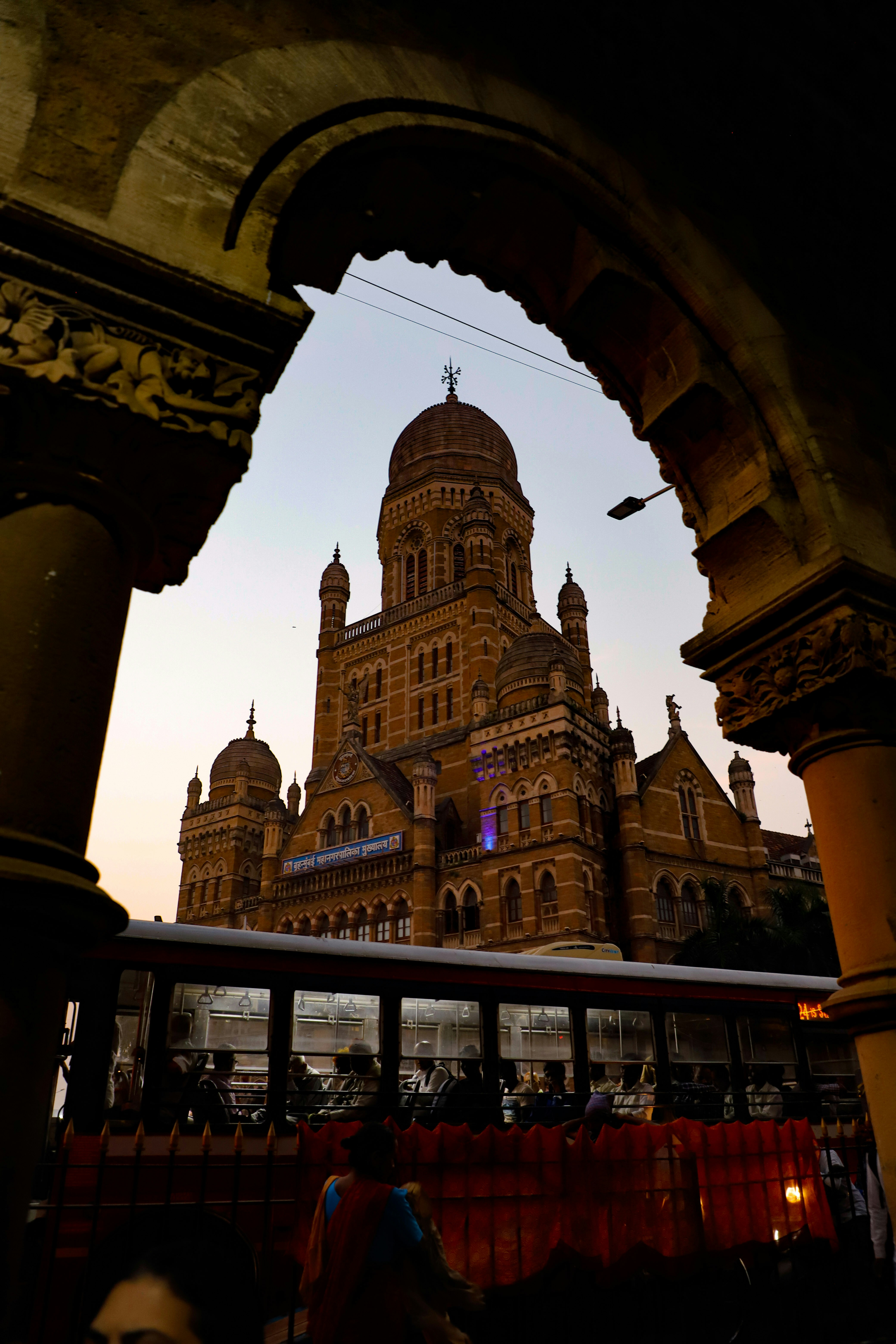 Arched Frame to Gothic Grandeur: A Palatial Facade Under Evening Light
