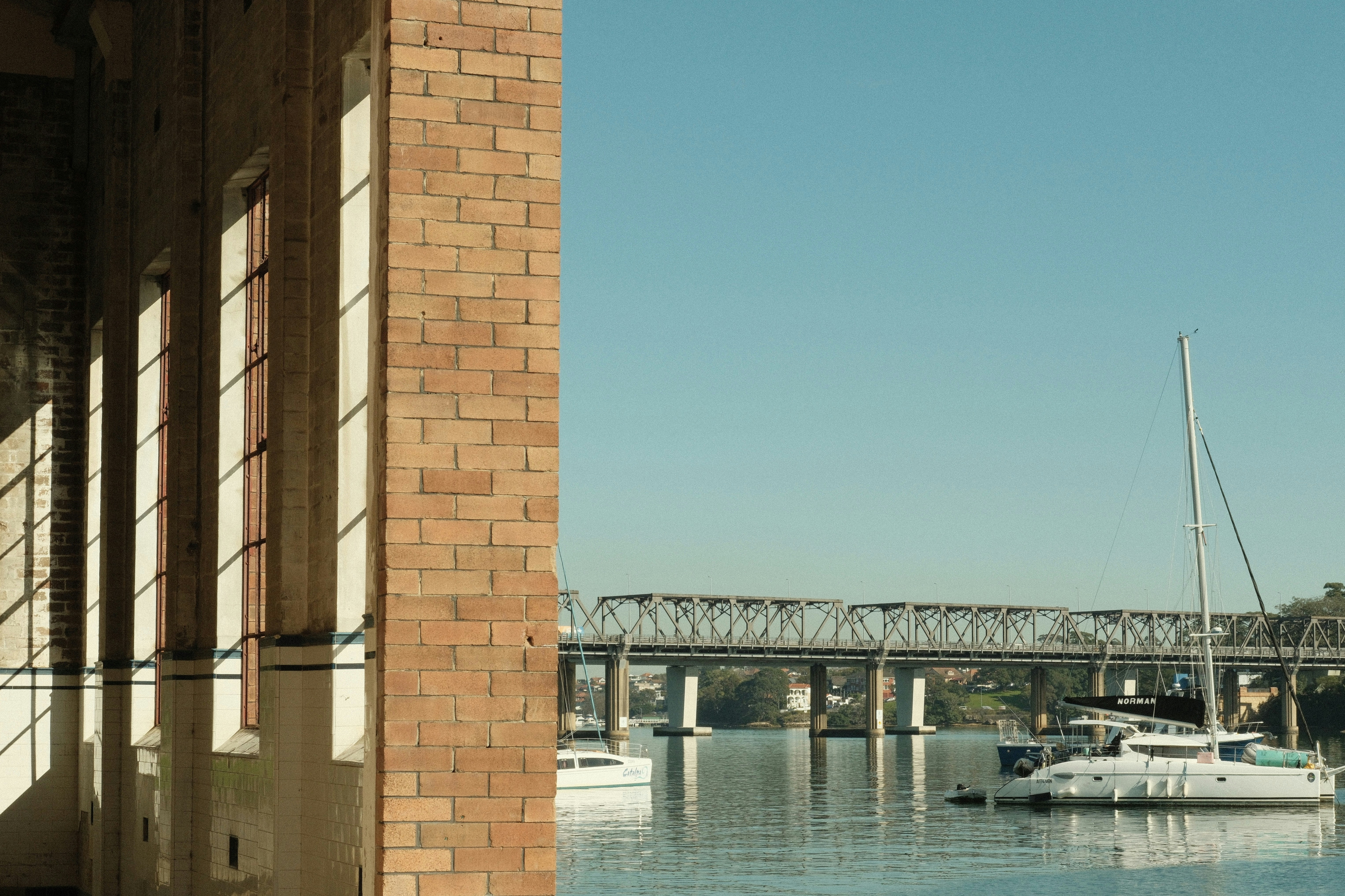 Brick Column Framing a Waterfront Bridge