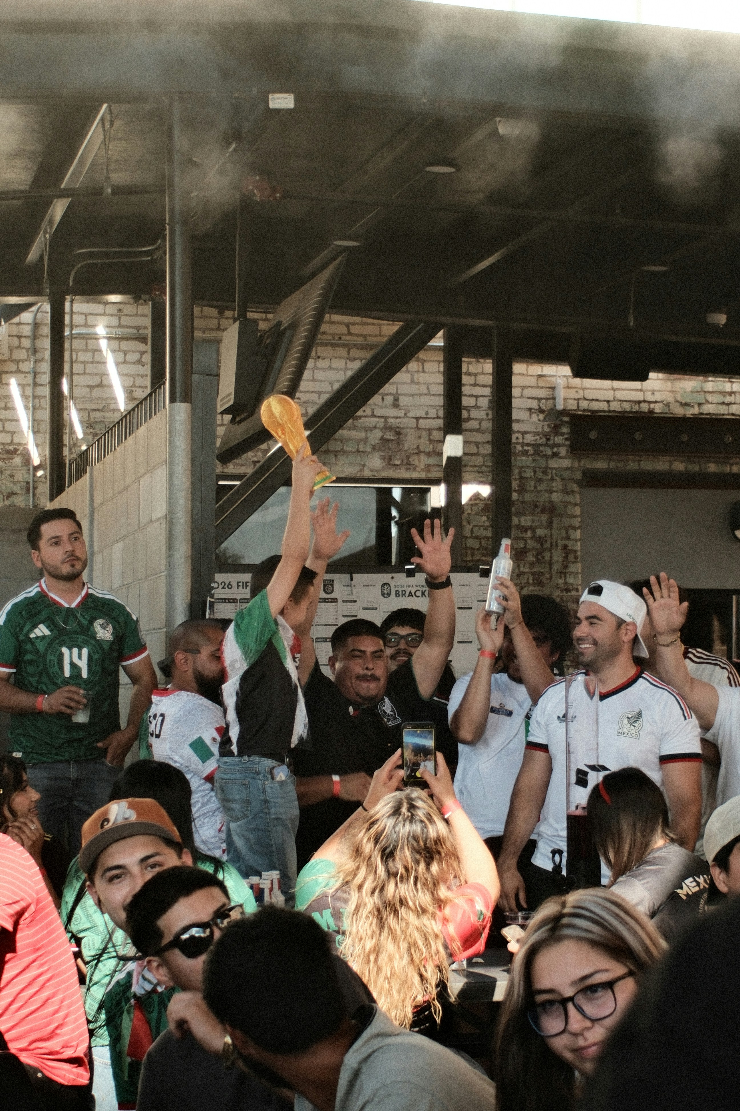 Celebration Toss: Trophy Moment in a Packed Venue
