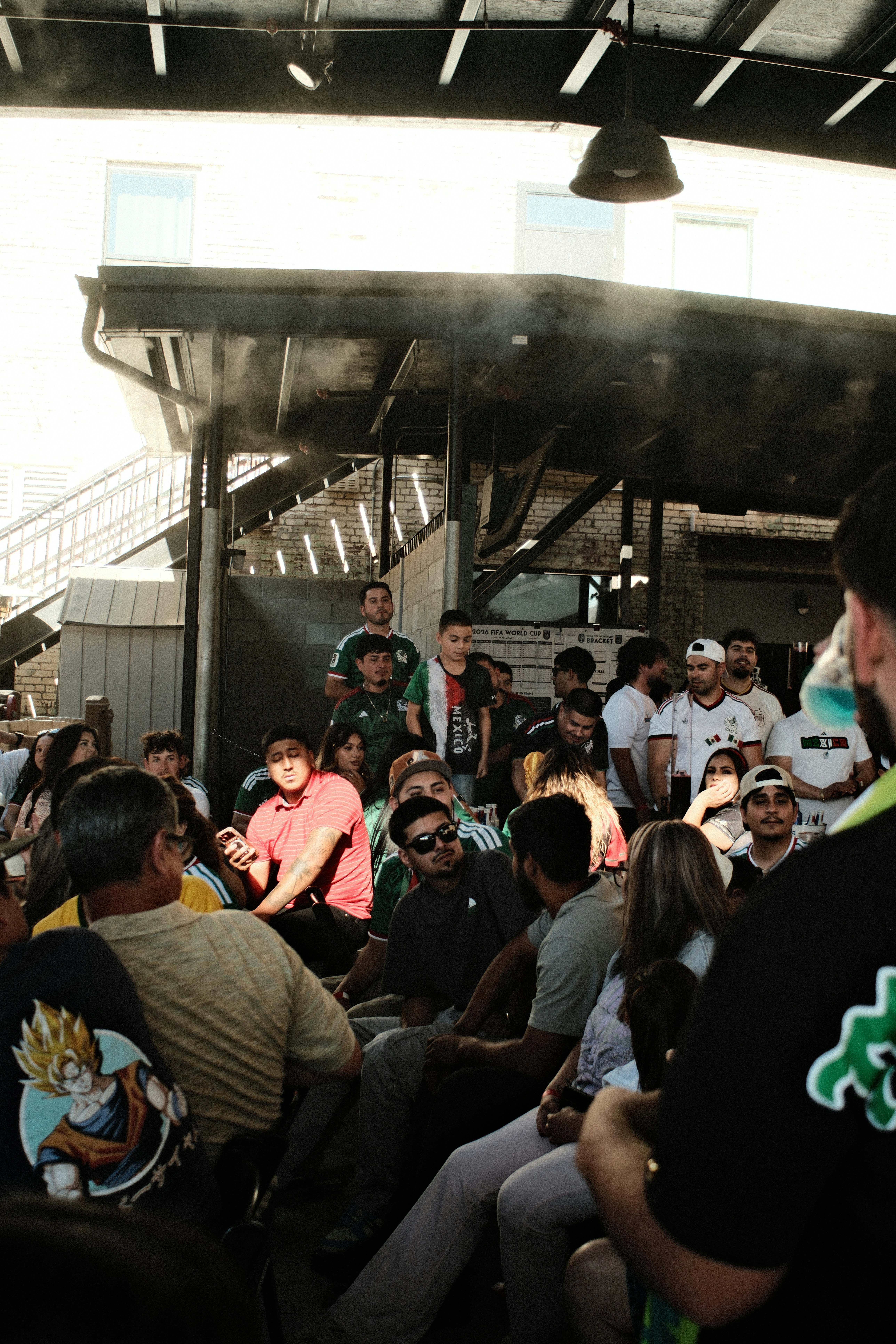 Crowd Gathering under an Open-Air Shelter with Focus on a Central Group