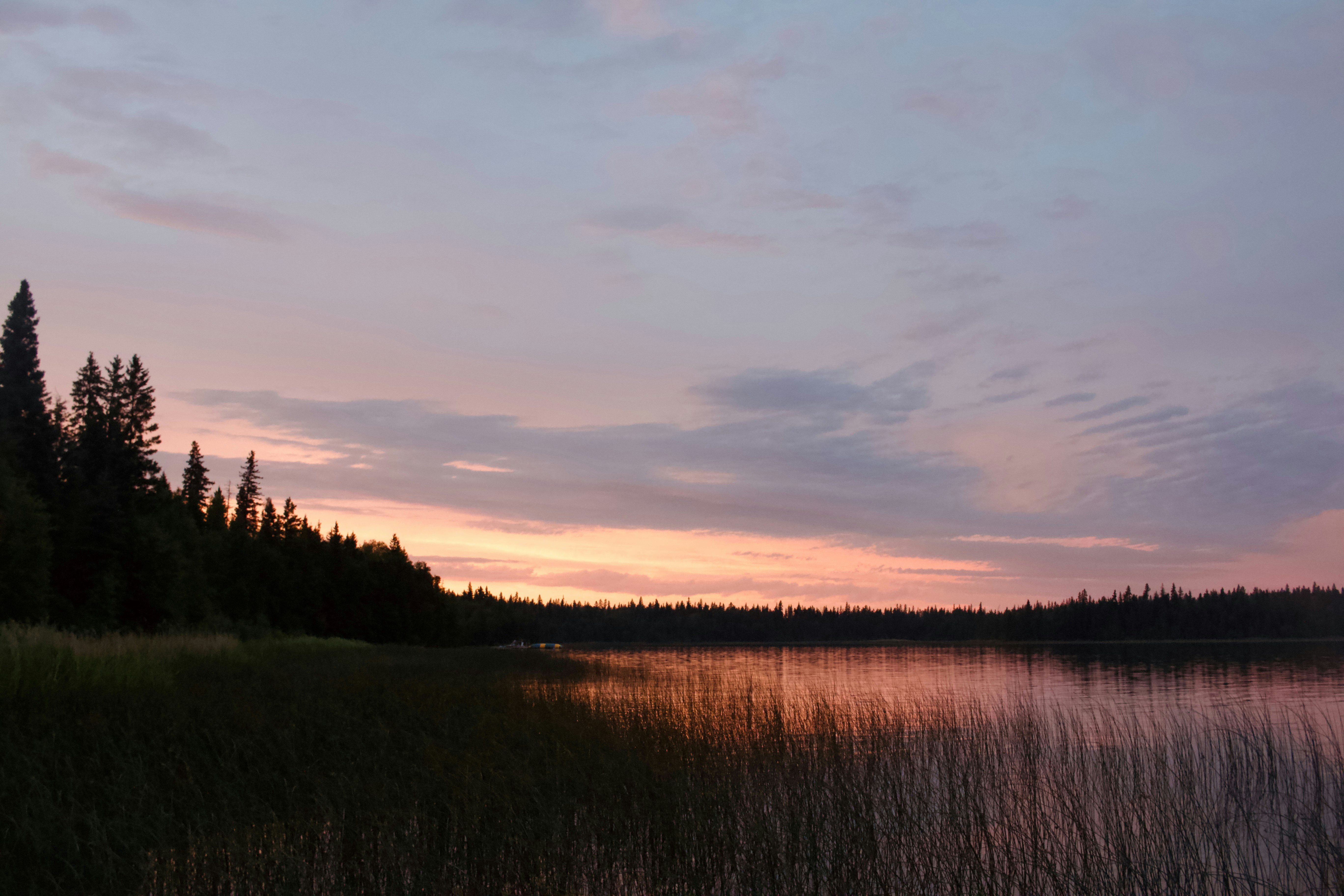 Sunset Silhouette Over a Serene Lake