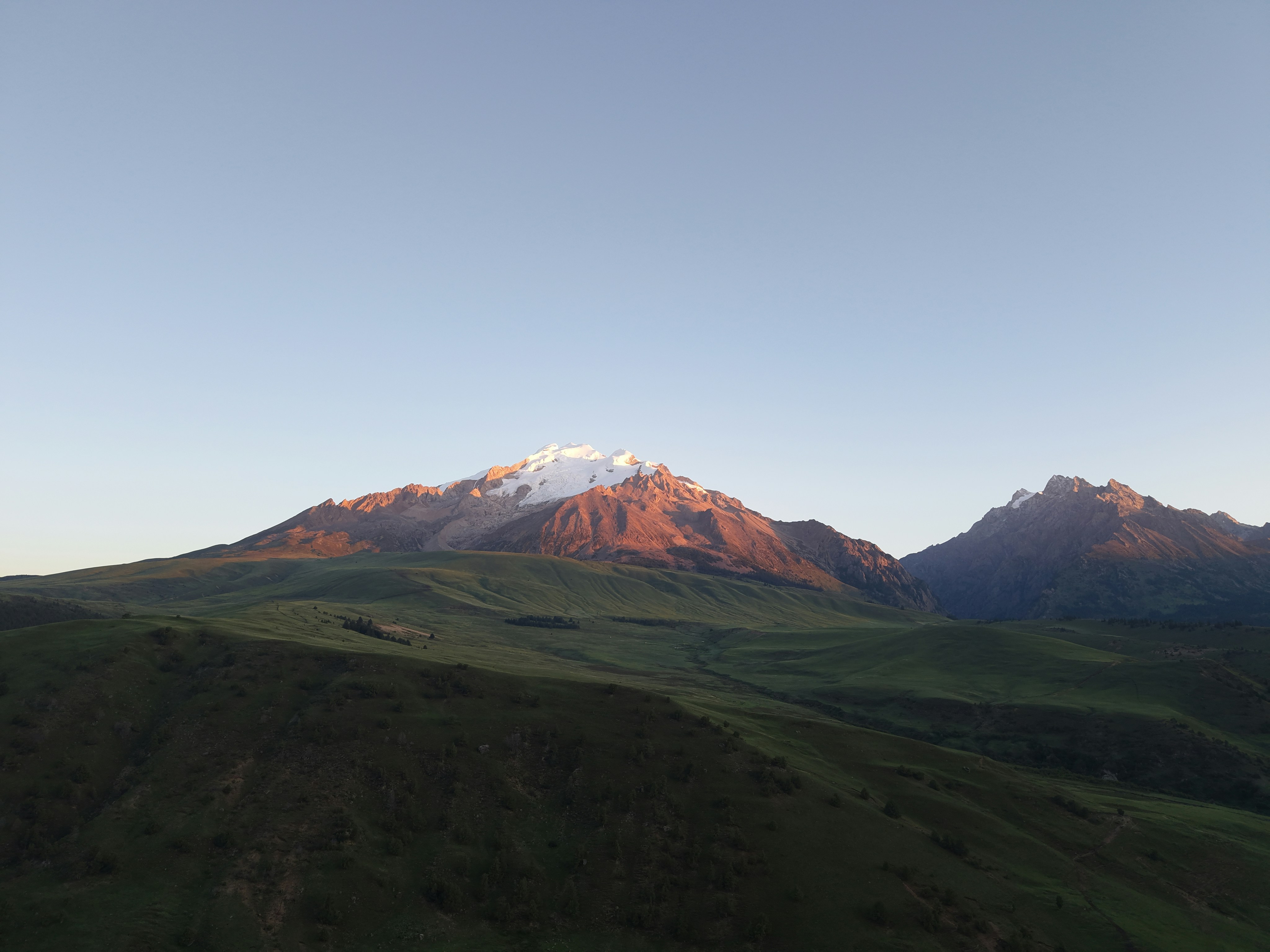 Sunrise Crown: A Glacier-Trimmed Peak Over Rolling Moorland