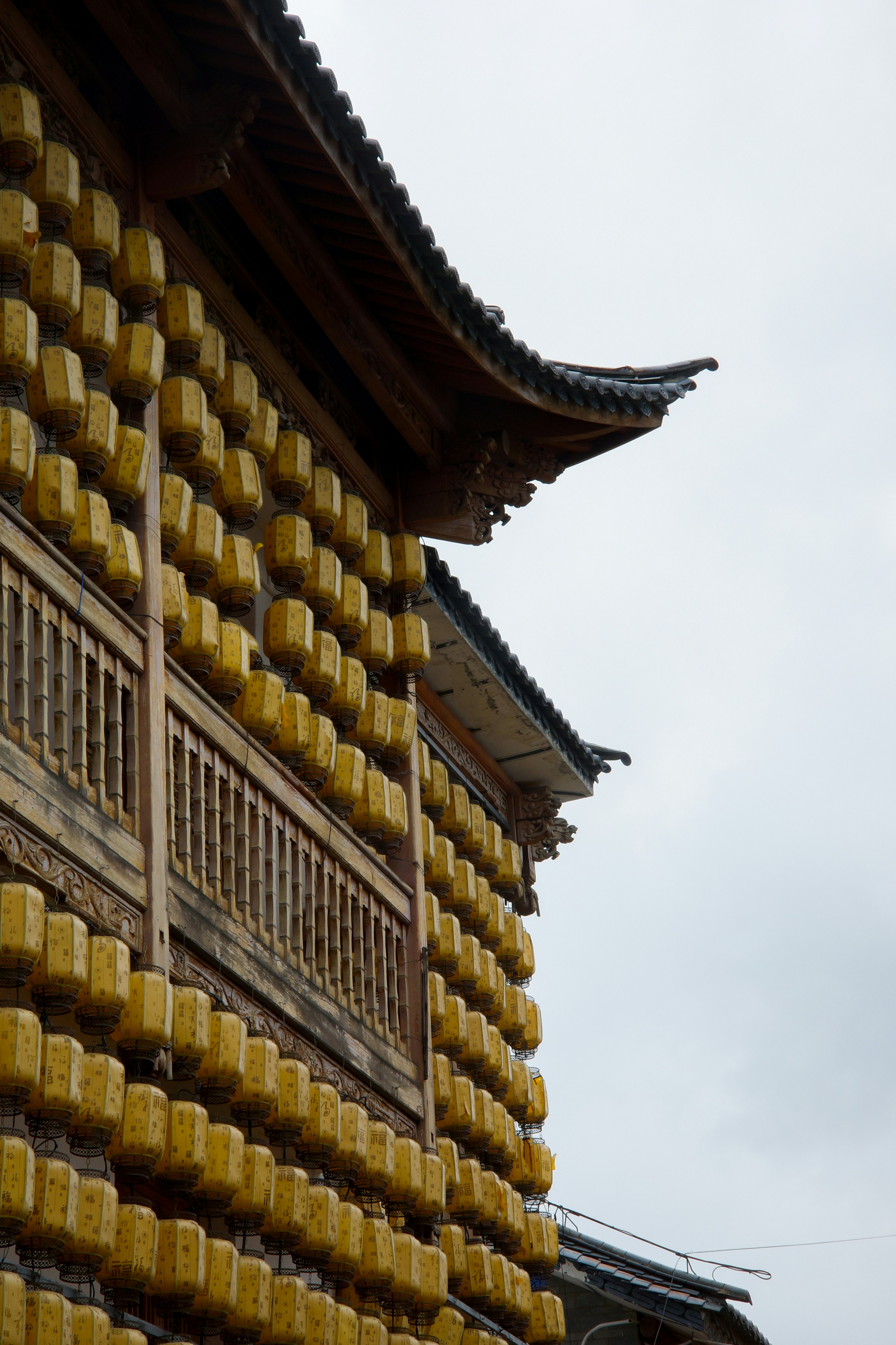 Ancient Facade: Rows of Lanterns along a Monumental Eave