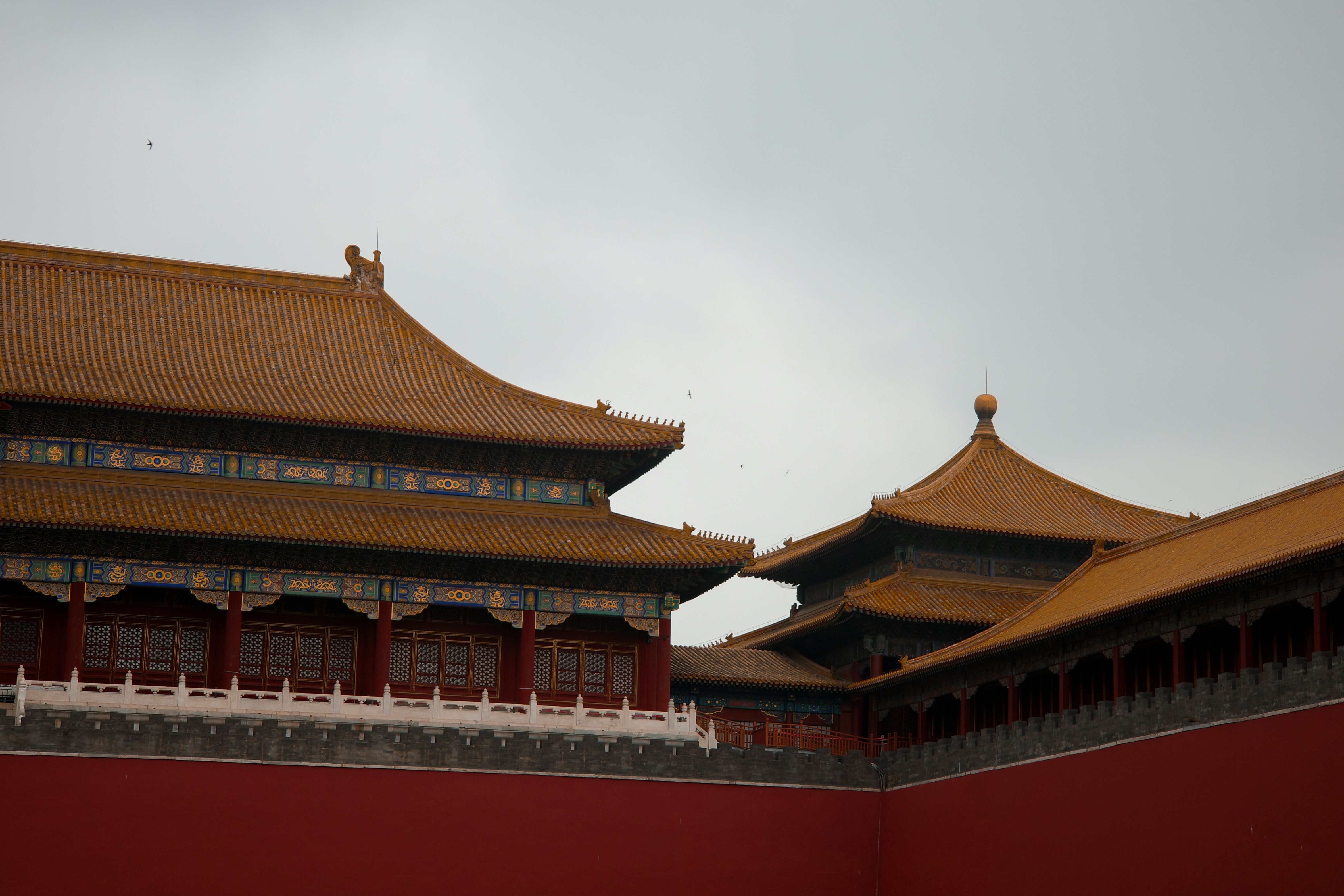 Golden Rooflines Over a Red Courtyard