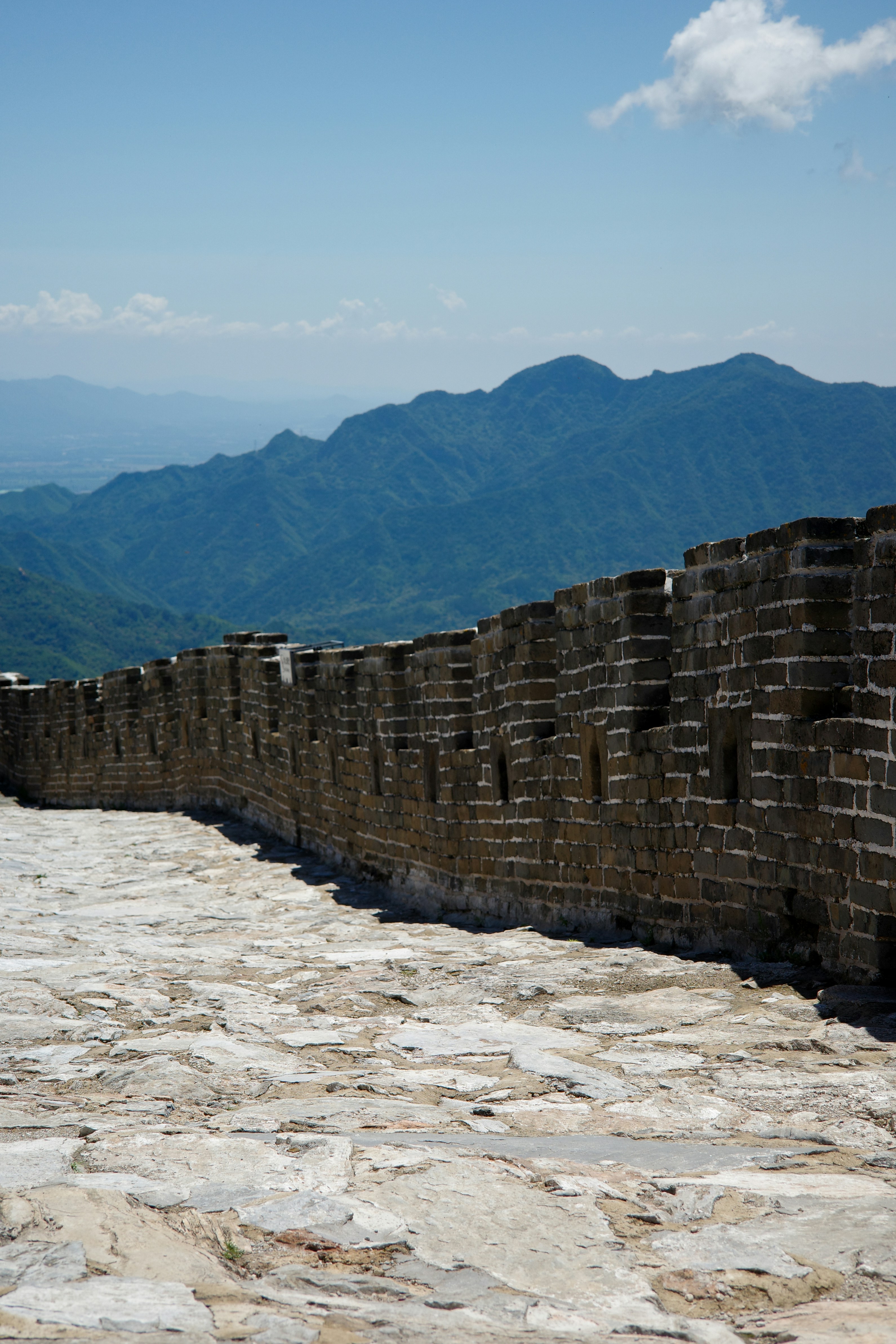 Stone Ramparts Over a Blue Fold: A Mountain Vista from the Wall